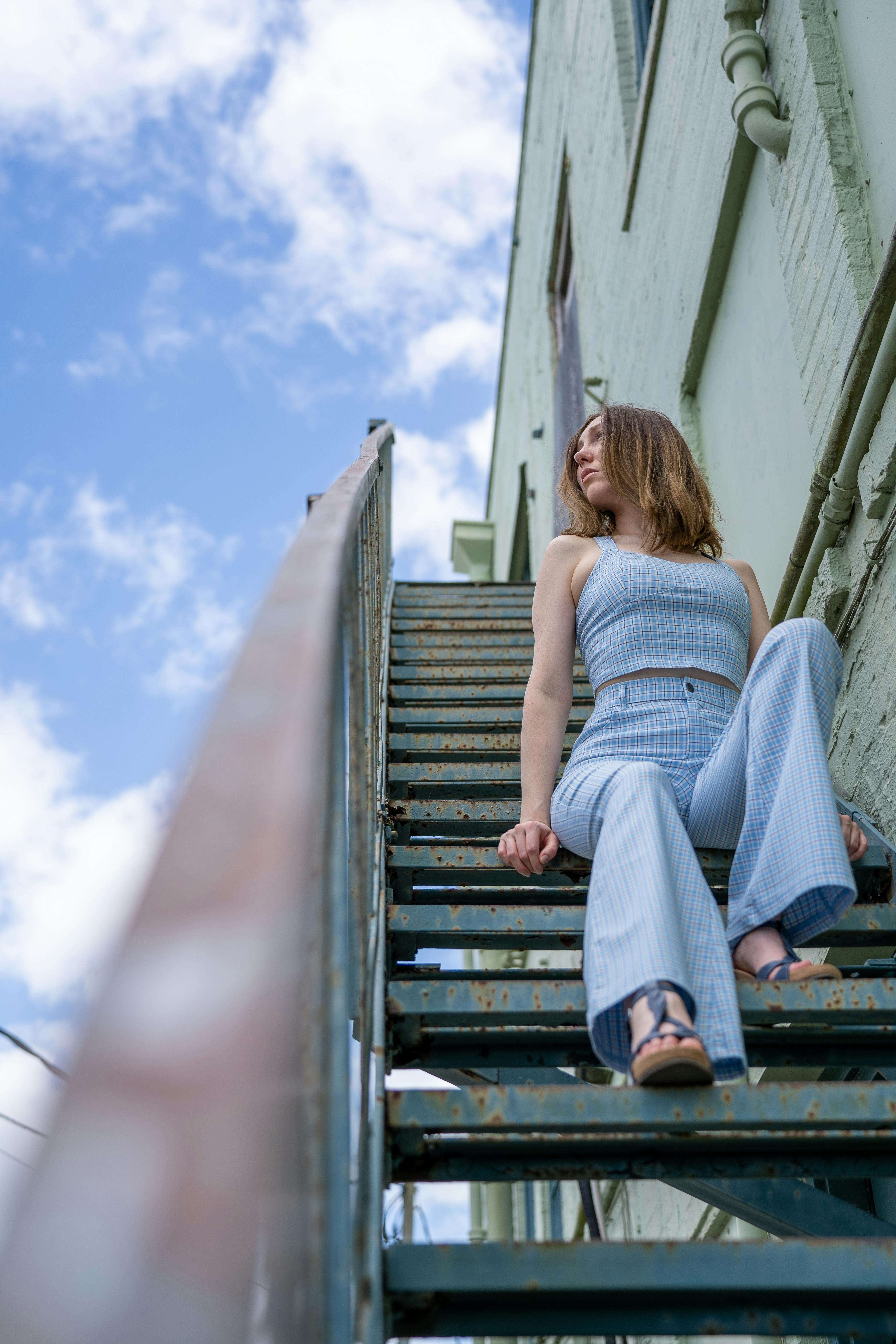 Low Angle Photo of Posing Woman in Black Pants and Golden Top Looking ...