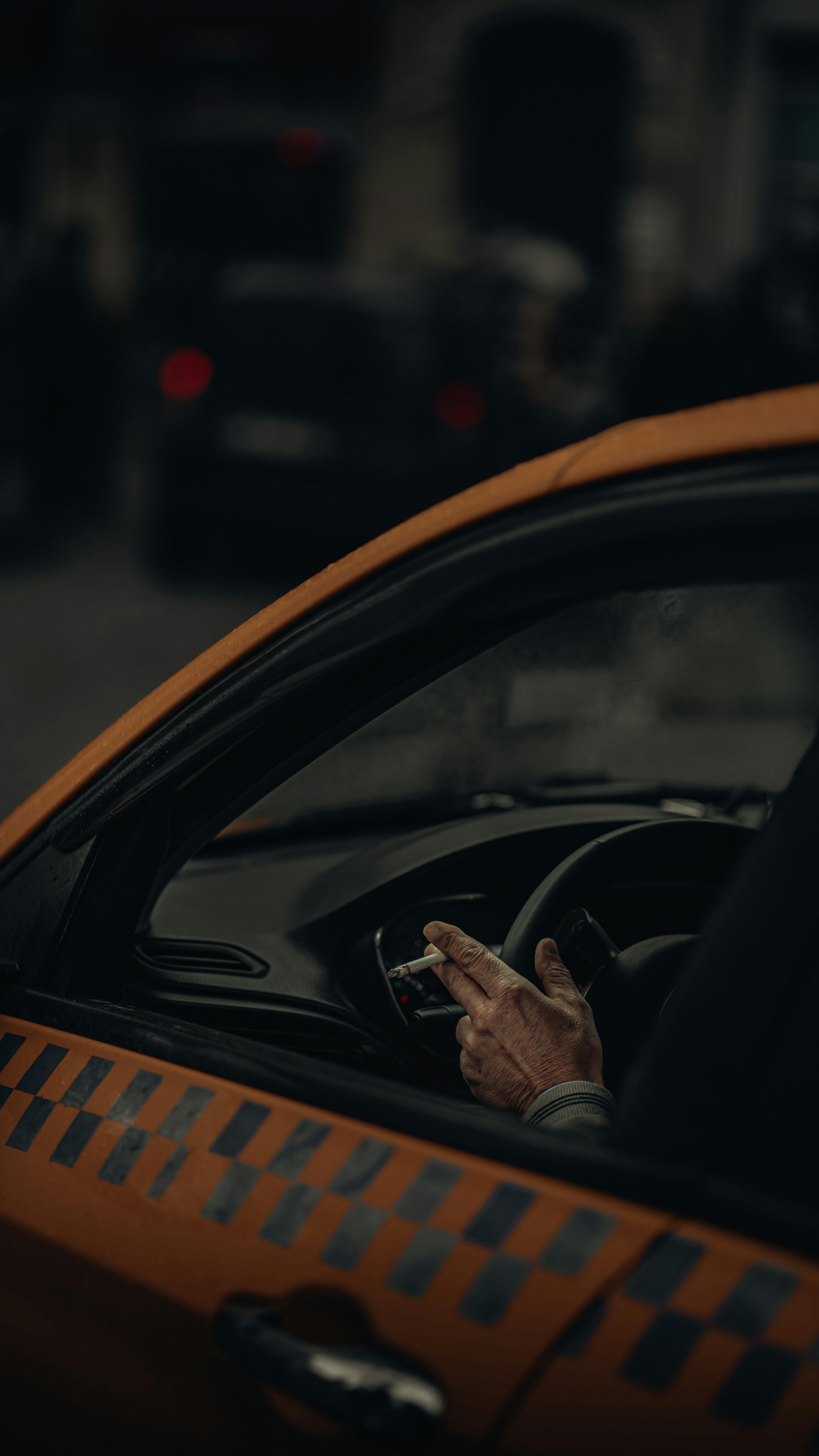 A Person Driving while Smoking a Cigarette · Free Stock Photo