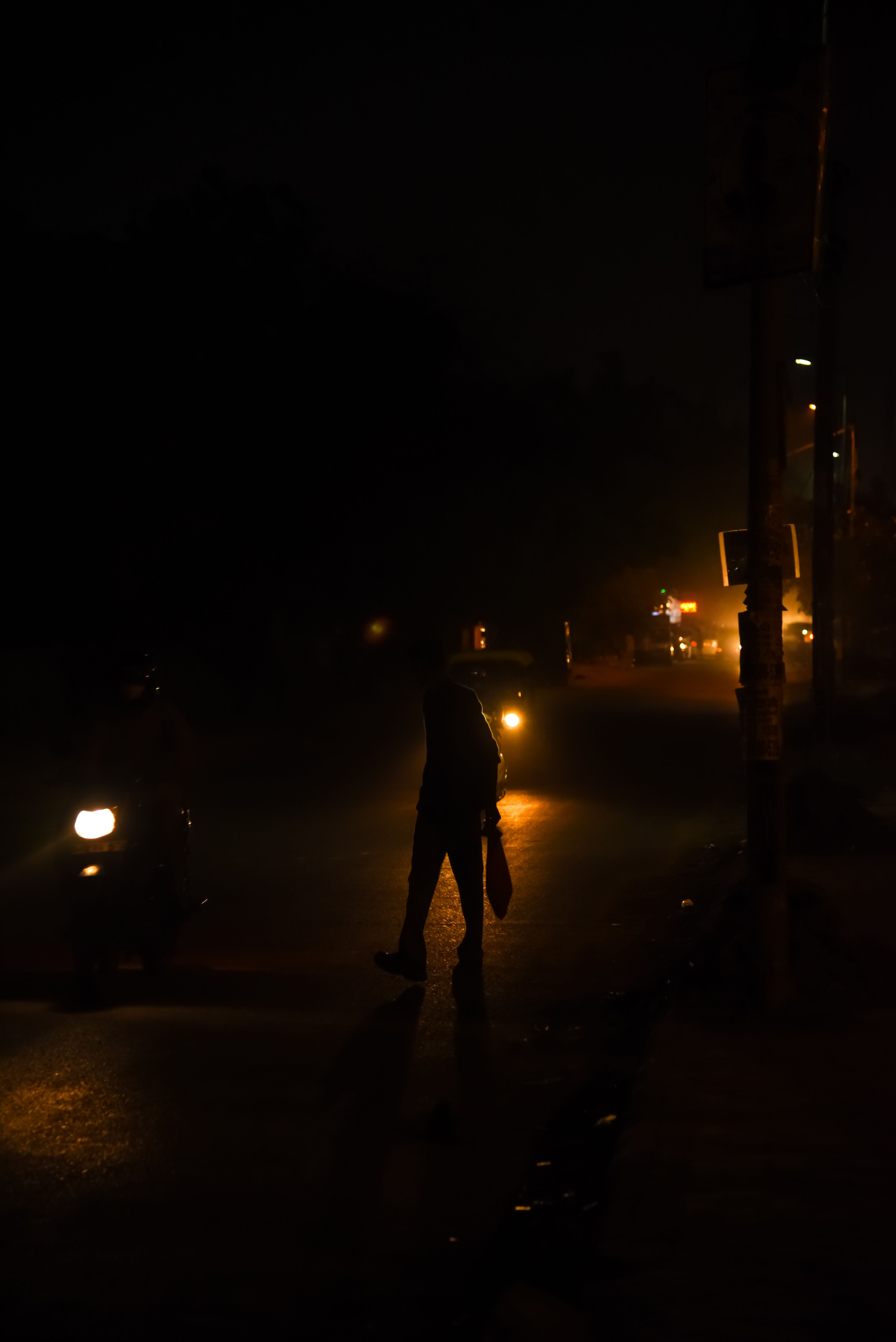 Man Standing in Front of Street Light Turned on · Free Stock Photo