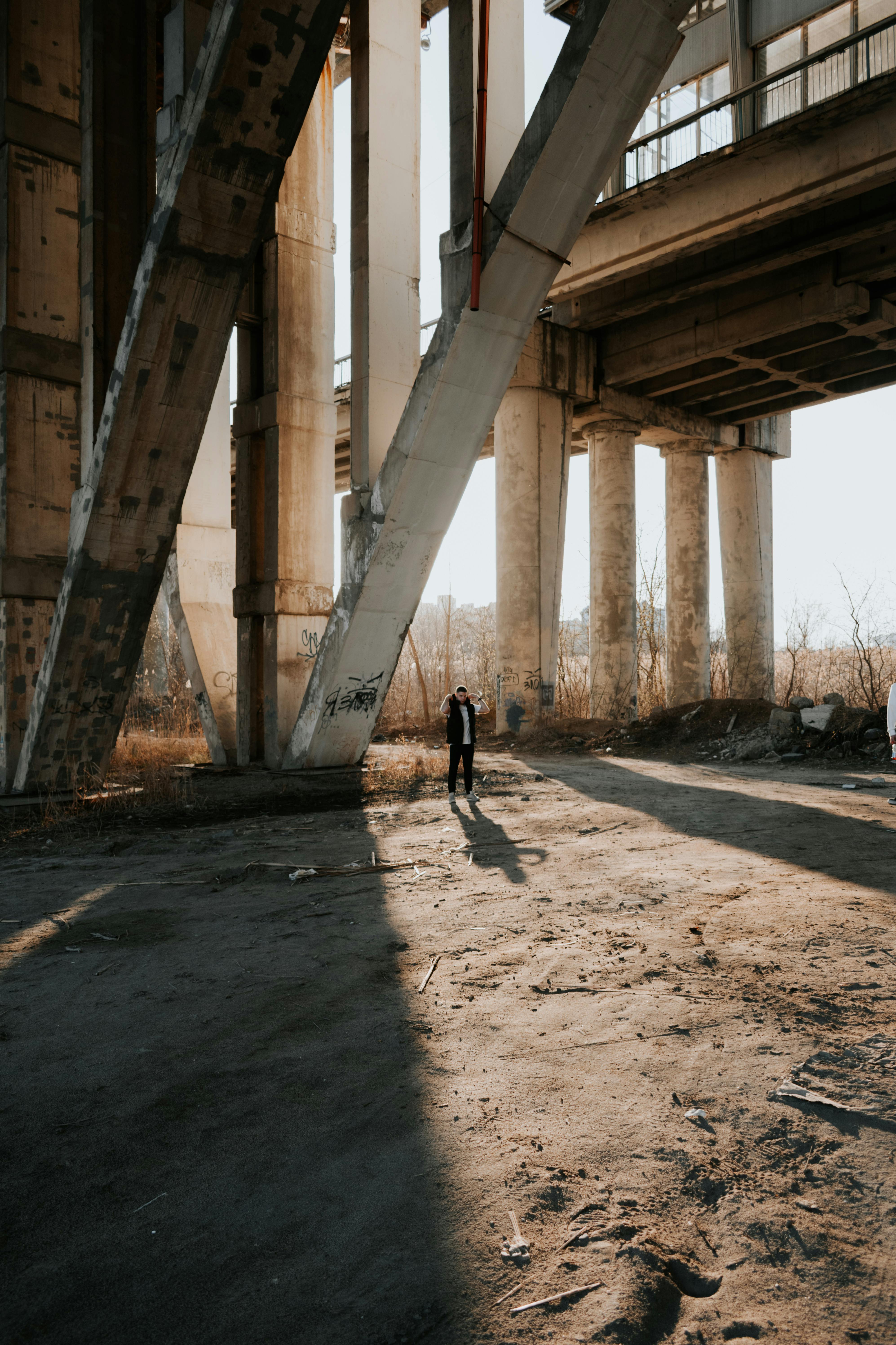 A Person Standing under the Bridge · Free Stock Photo
