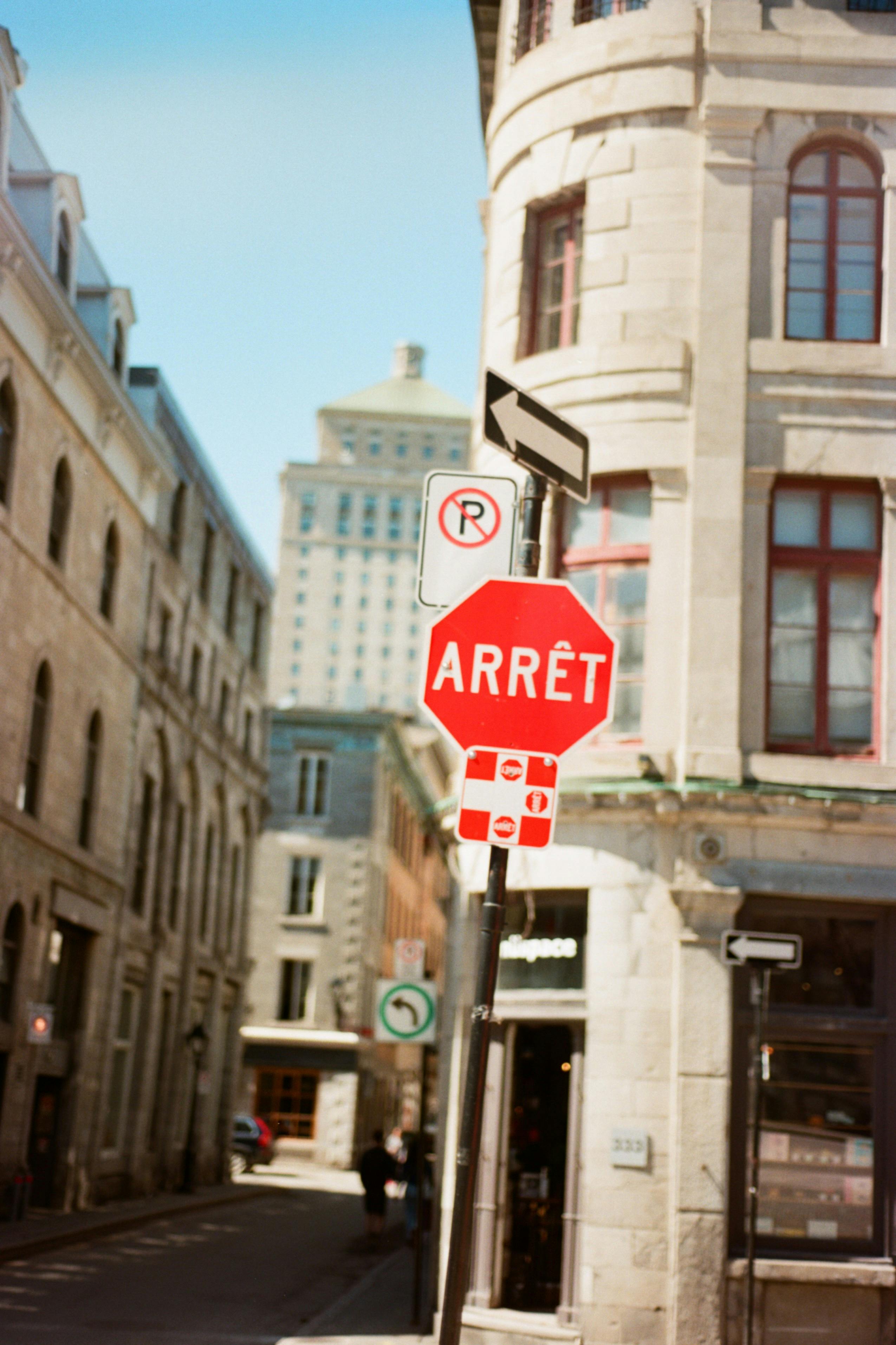 Red Stop Sign at Street Corner by Building · Free Stock Photo
