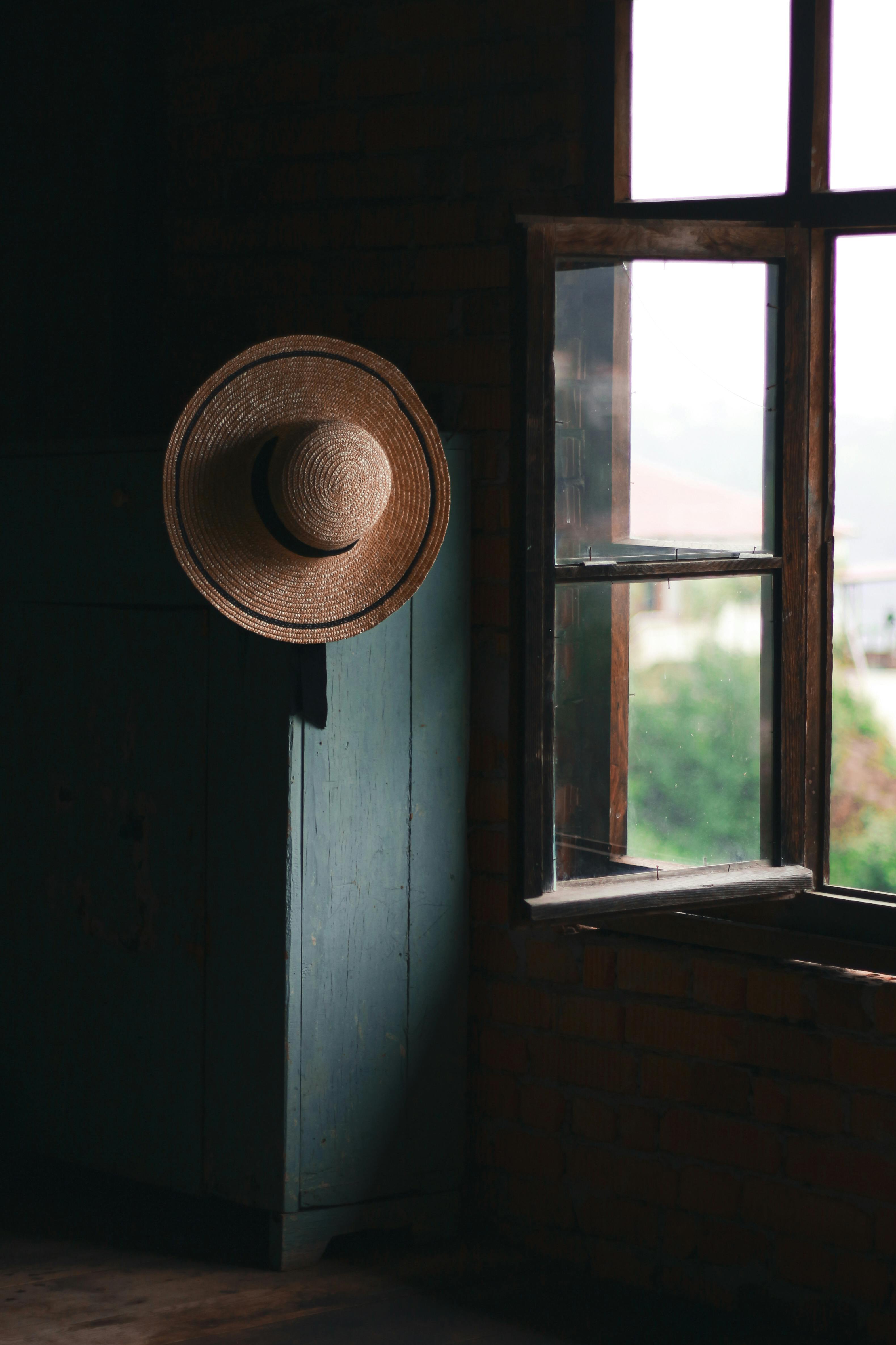 Straw Hat Hanging by Window in Hut · Free Stock Photo