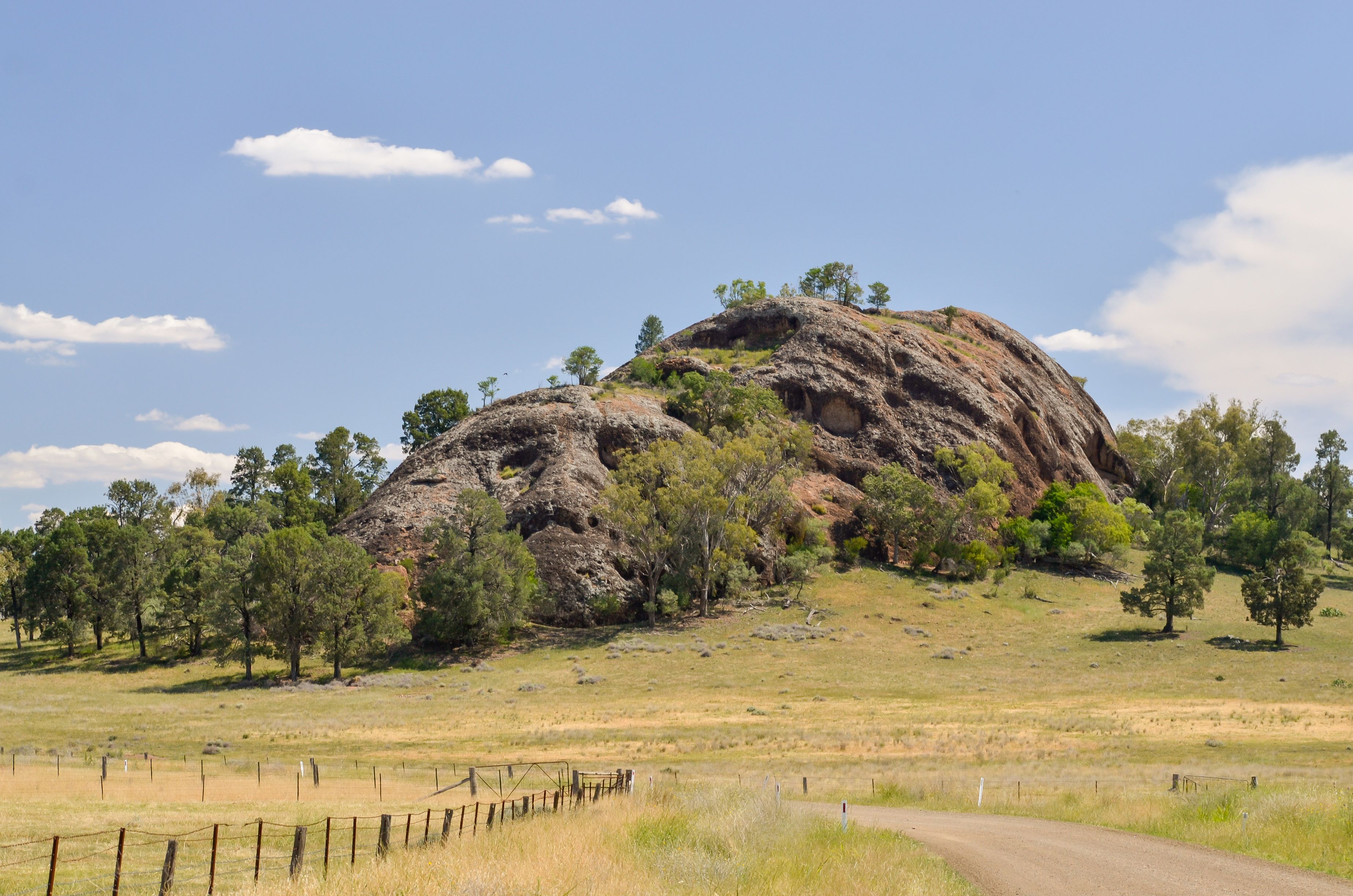 Brown Rock Formation on Grass Field Under Blue Sky · Free Stock Photo