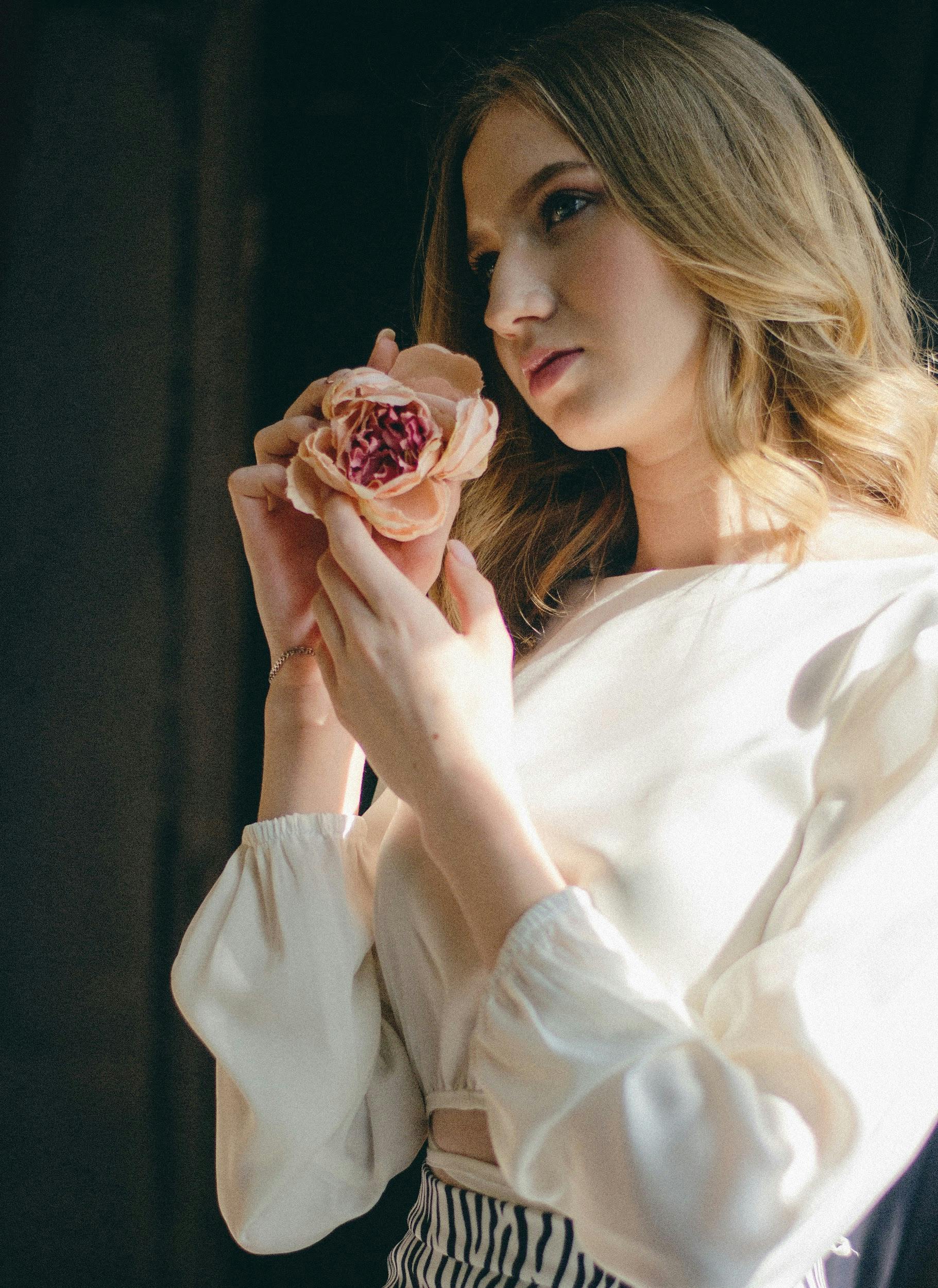 Woman Holding a Pink Rose Flower · Free Stock Photo