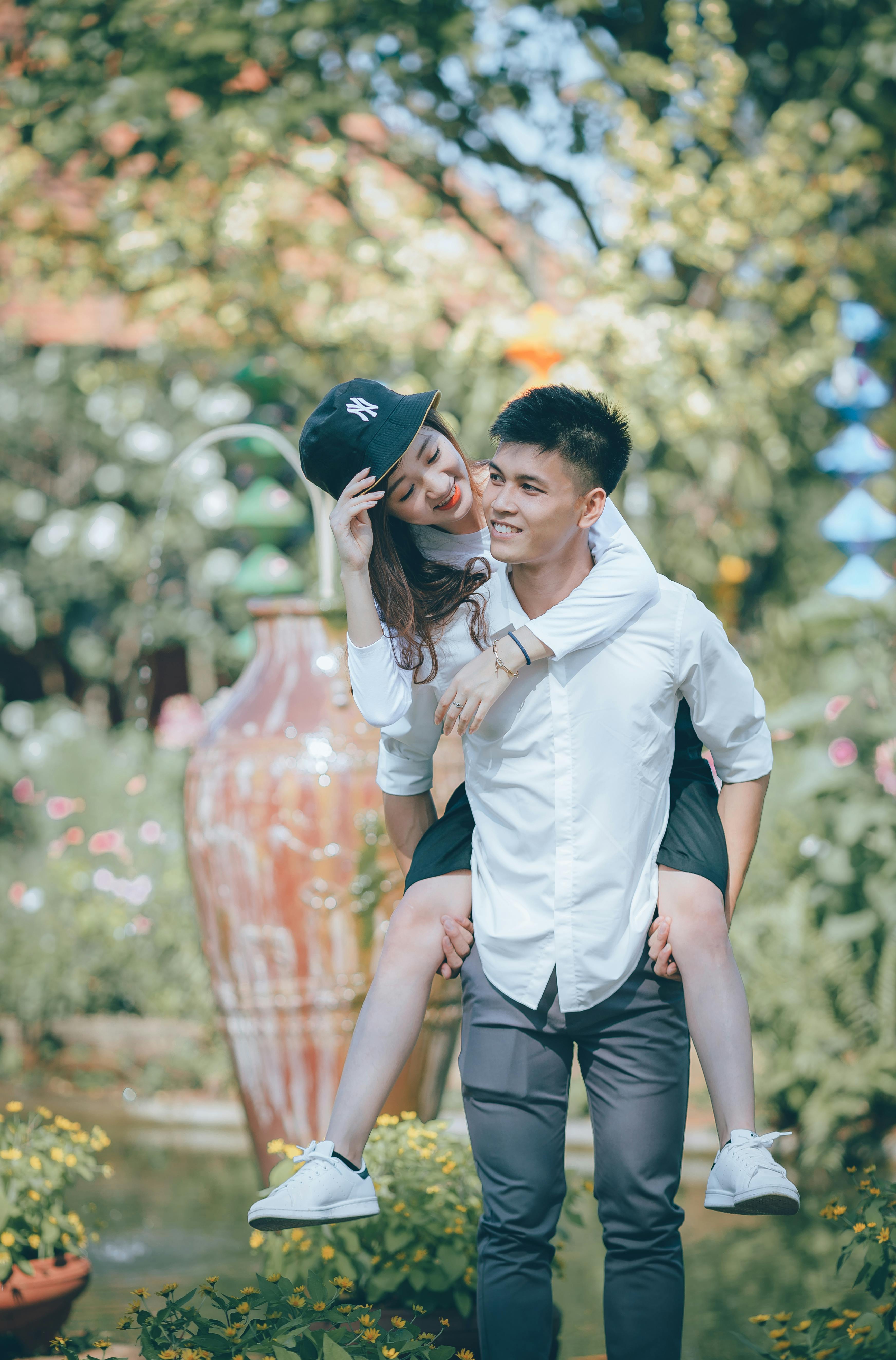A Man Carrying a Woman on His Shoulder · Free Stock Photo