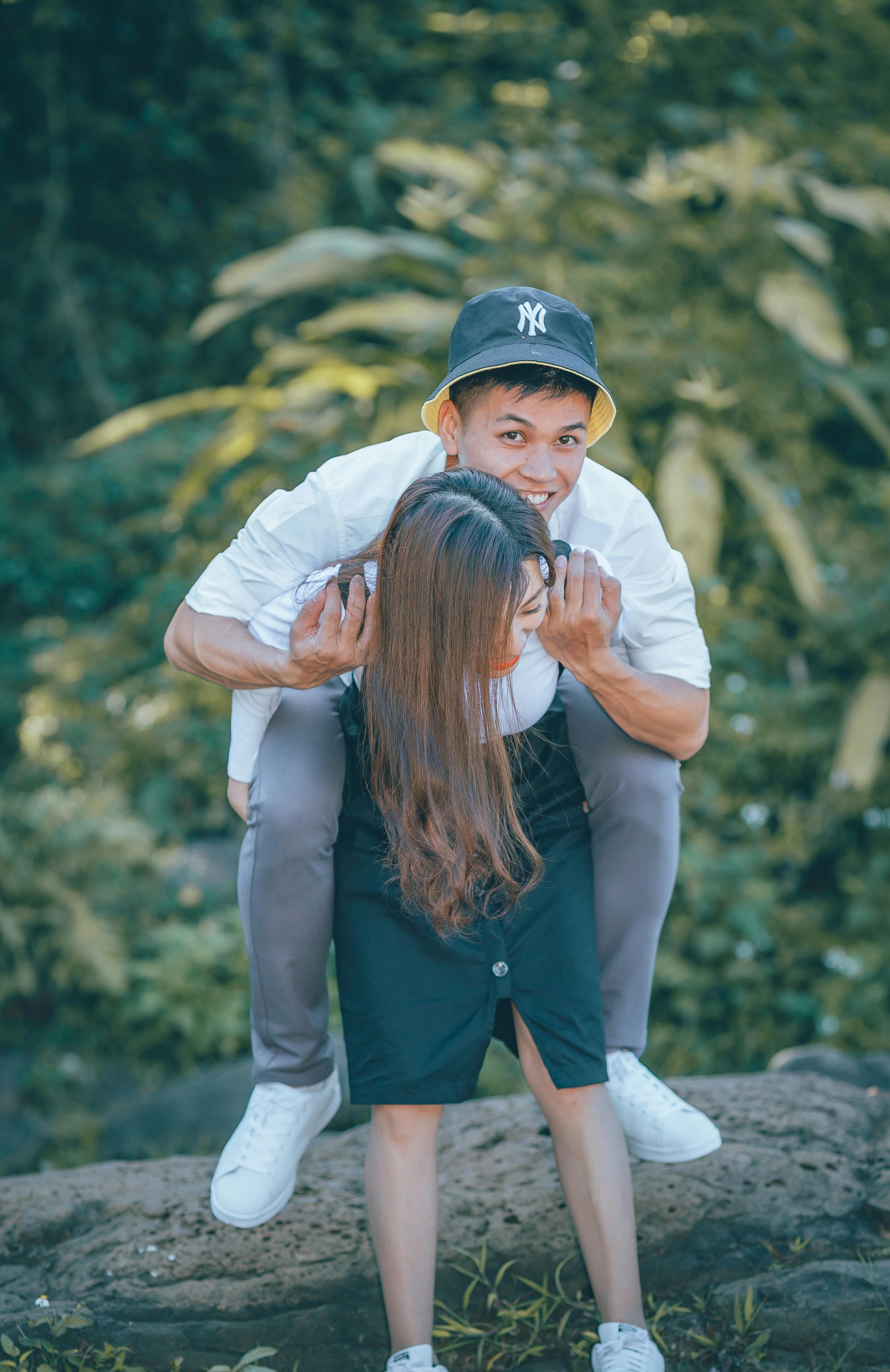 Photo of a Woman Carrying a Man · Free Stock Photo