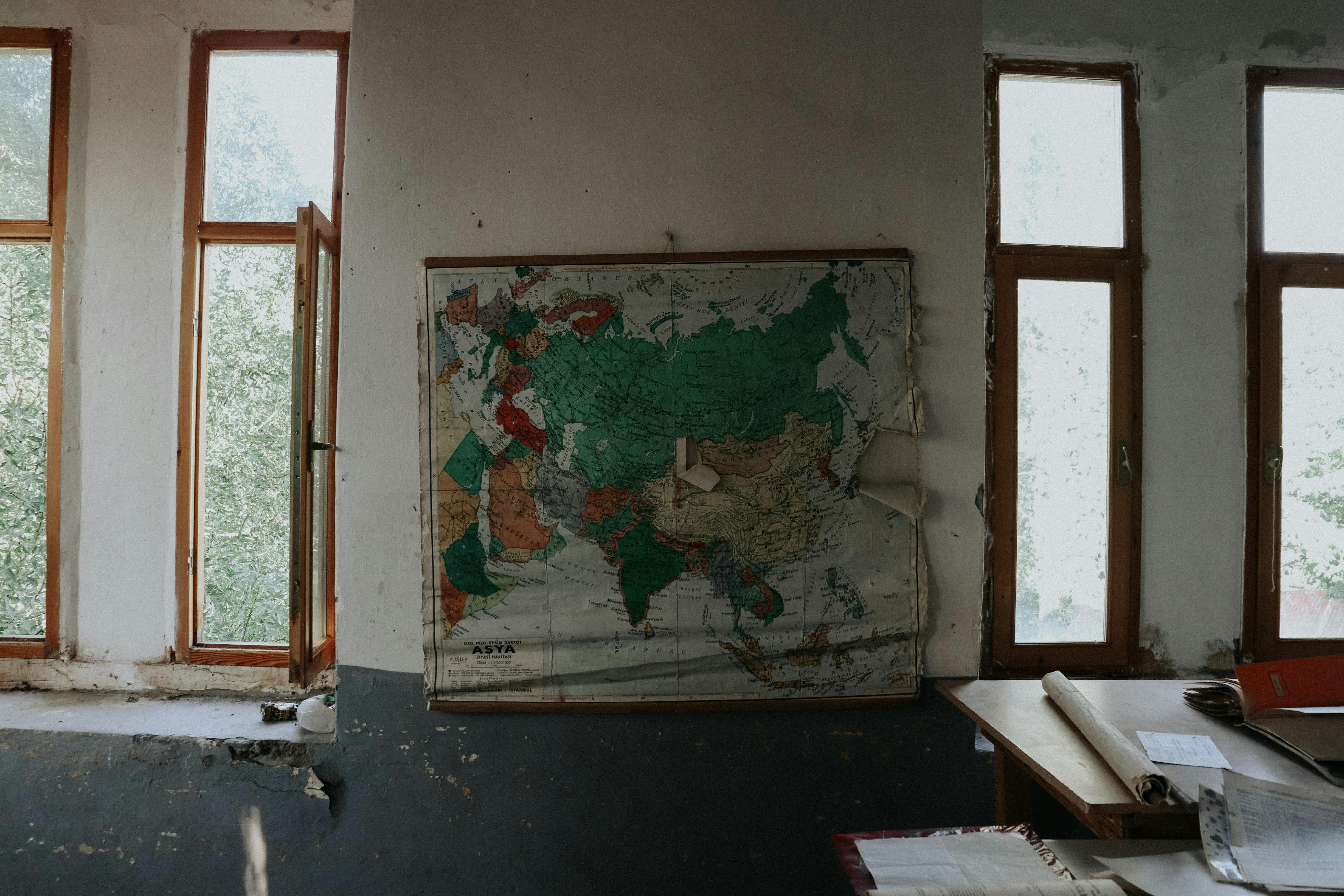 AN Old Map Hanging on the Wall Between Glass Windows · Free Stock Photo