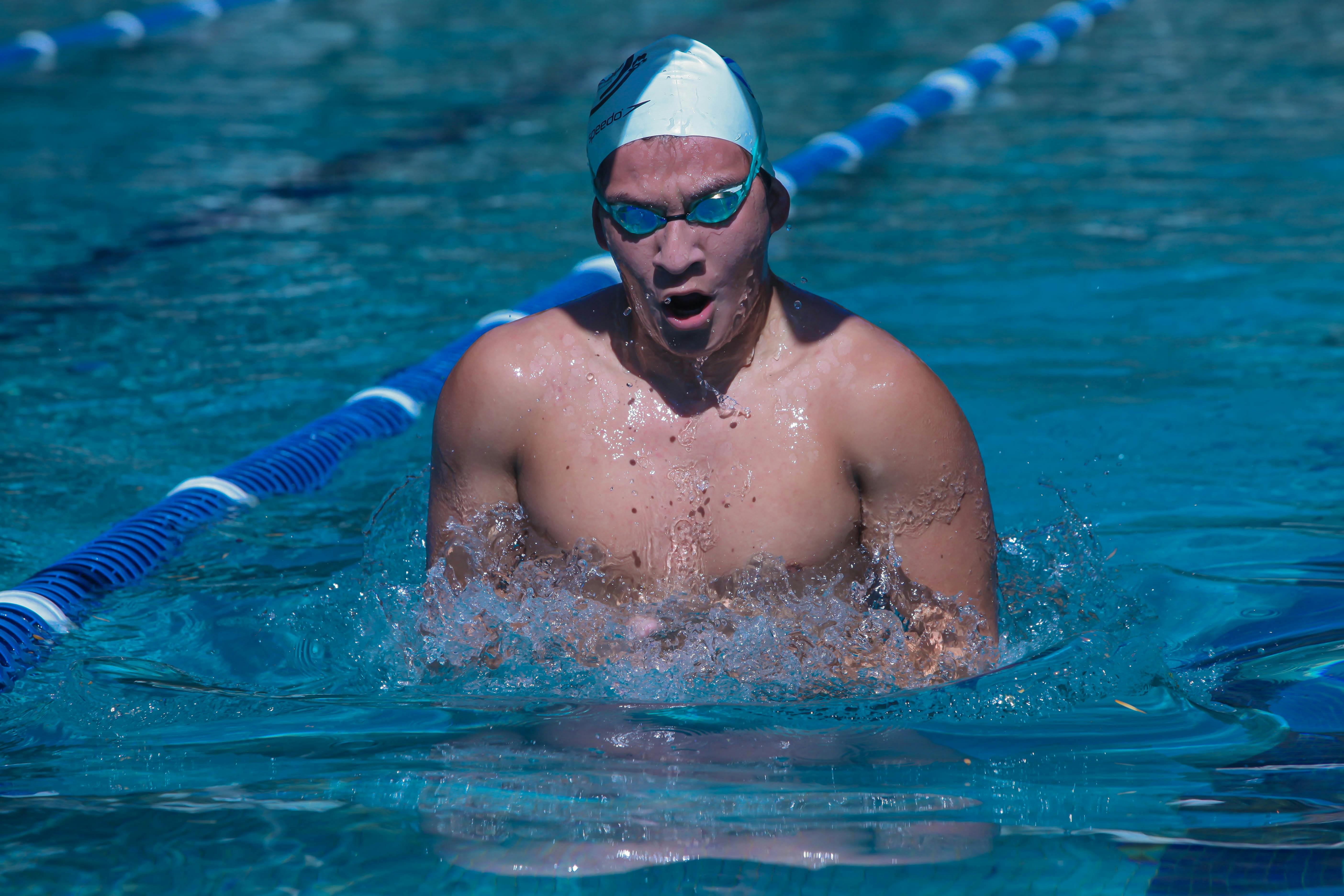 Person Swimming on Body of Water · Free Stock Photo