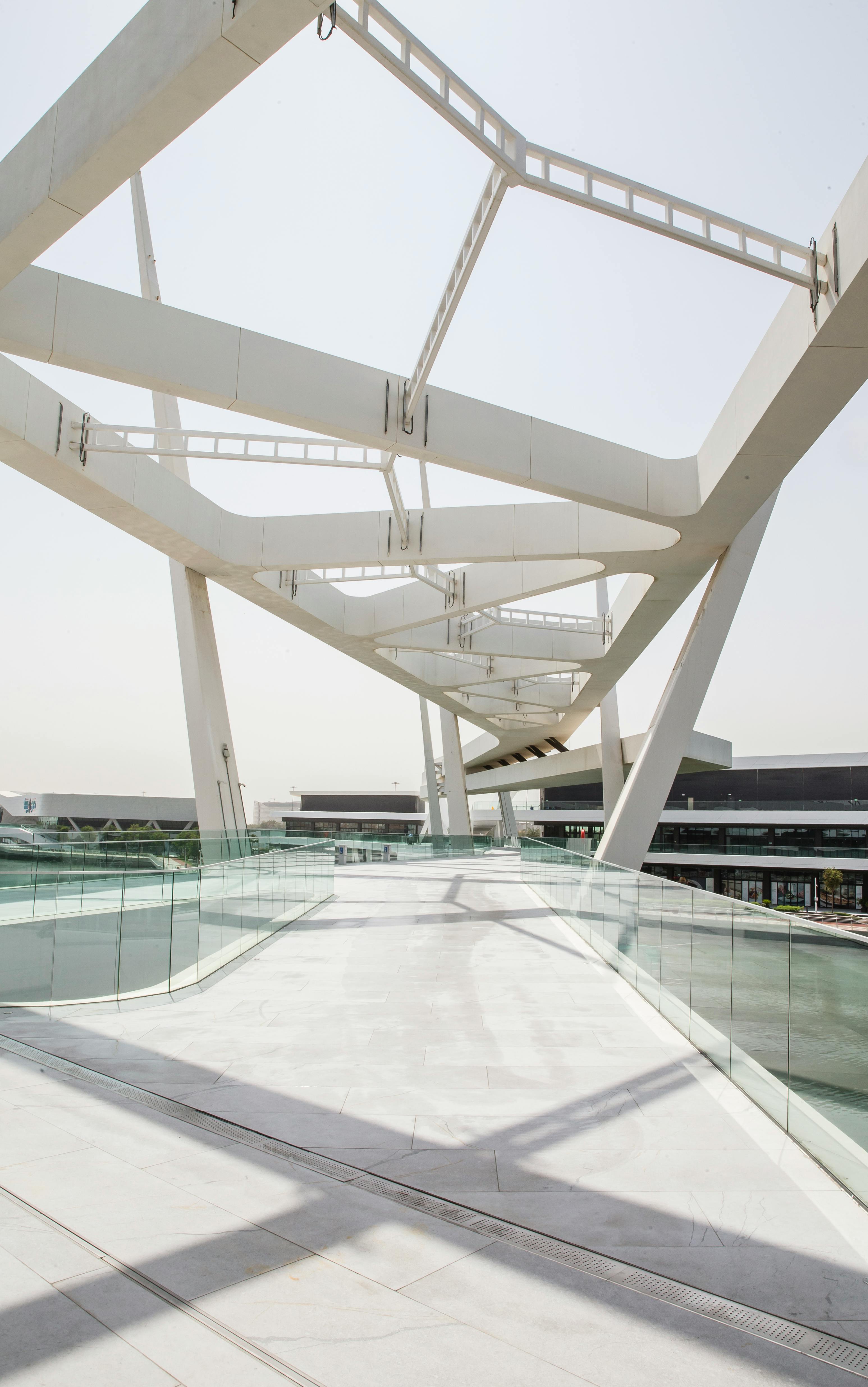 People Walking down the Elevated Footbridge · Free Stock Photo