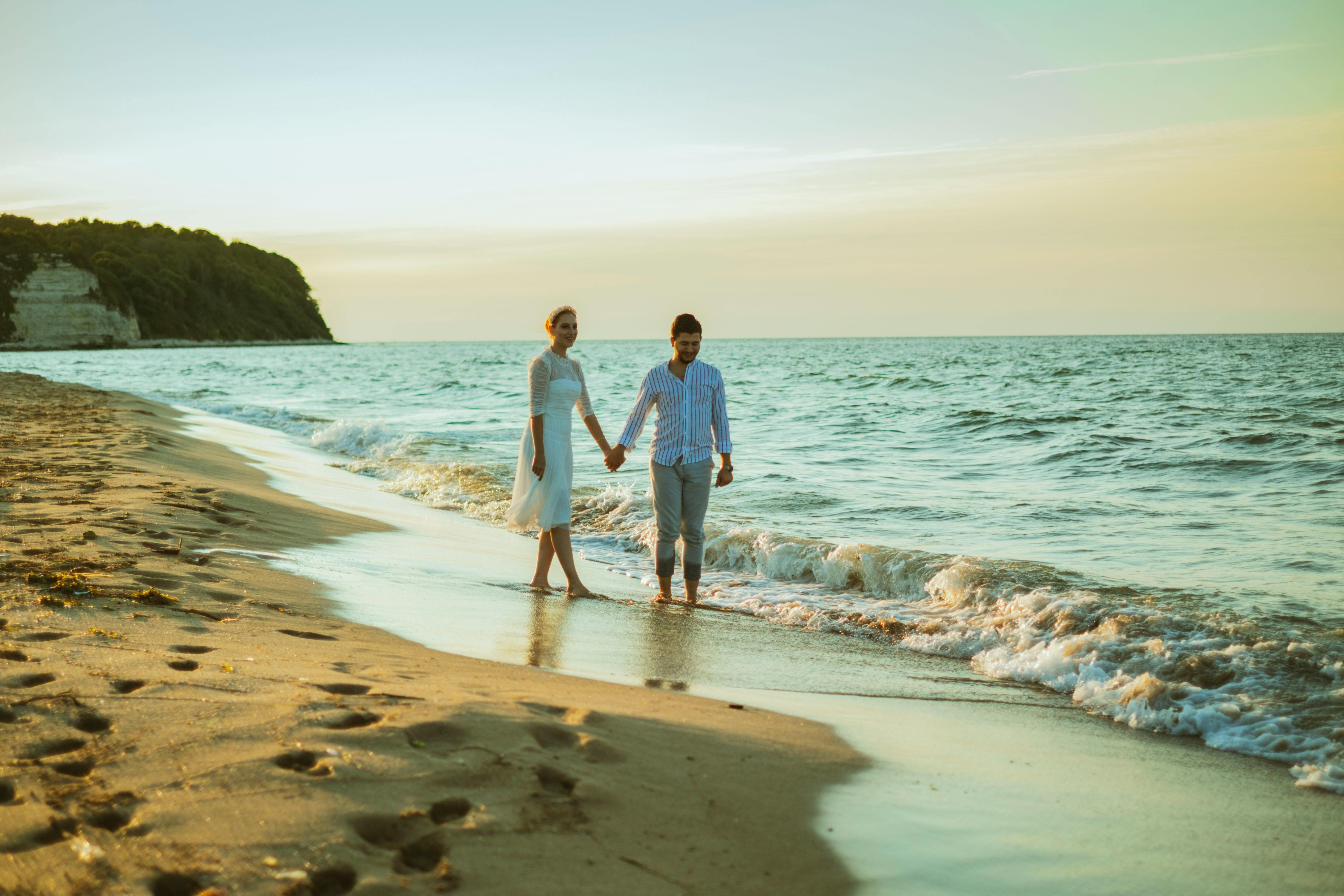 Gray Scale of Two Couples on the Beach · Free Stock Photo