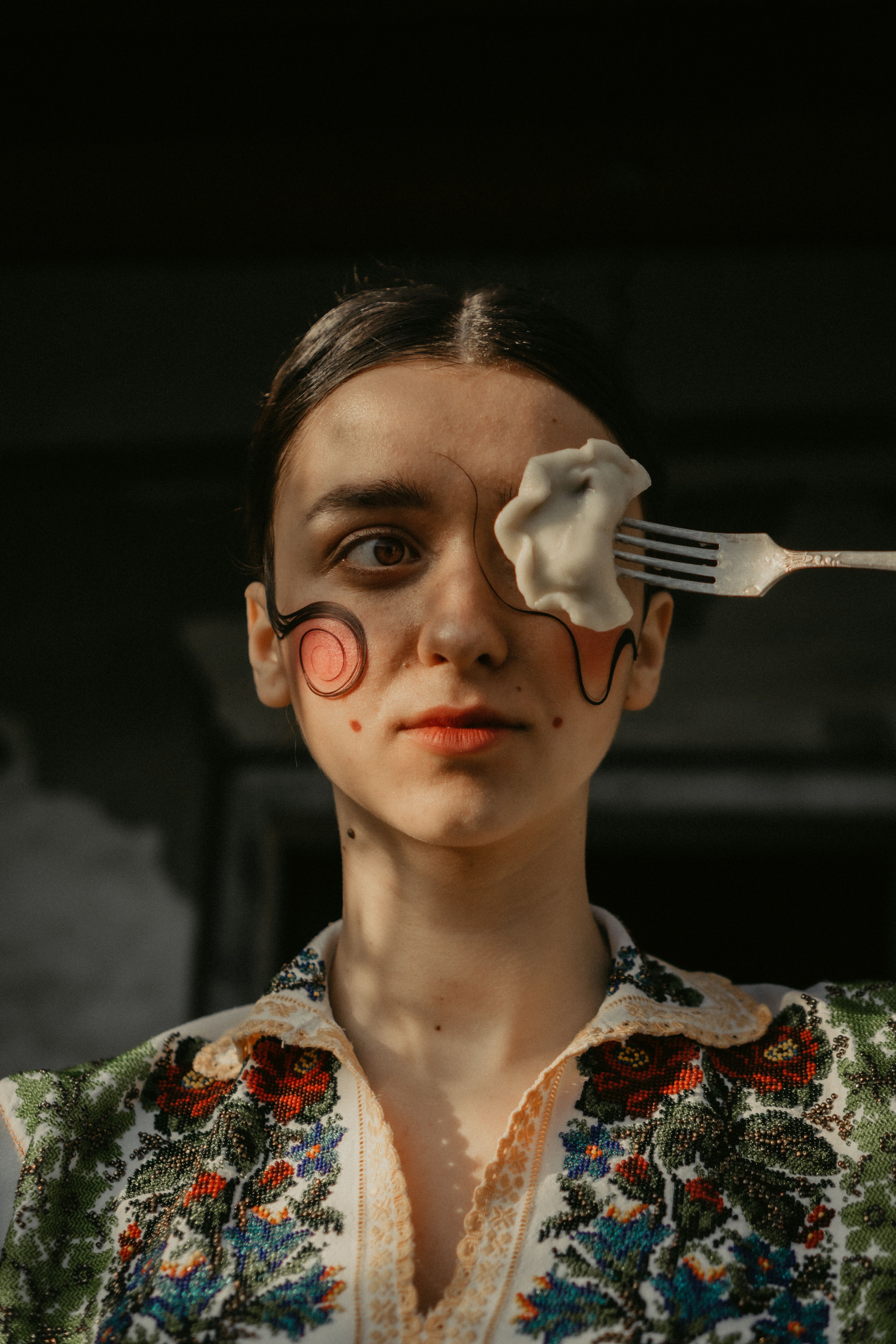 A Woman with Hair Stuck of Face Covering Her Eye with Dimsum on Fork ...
