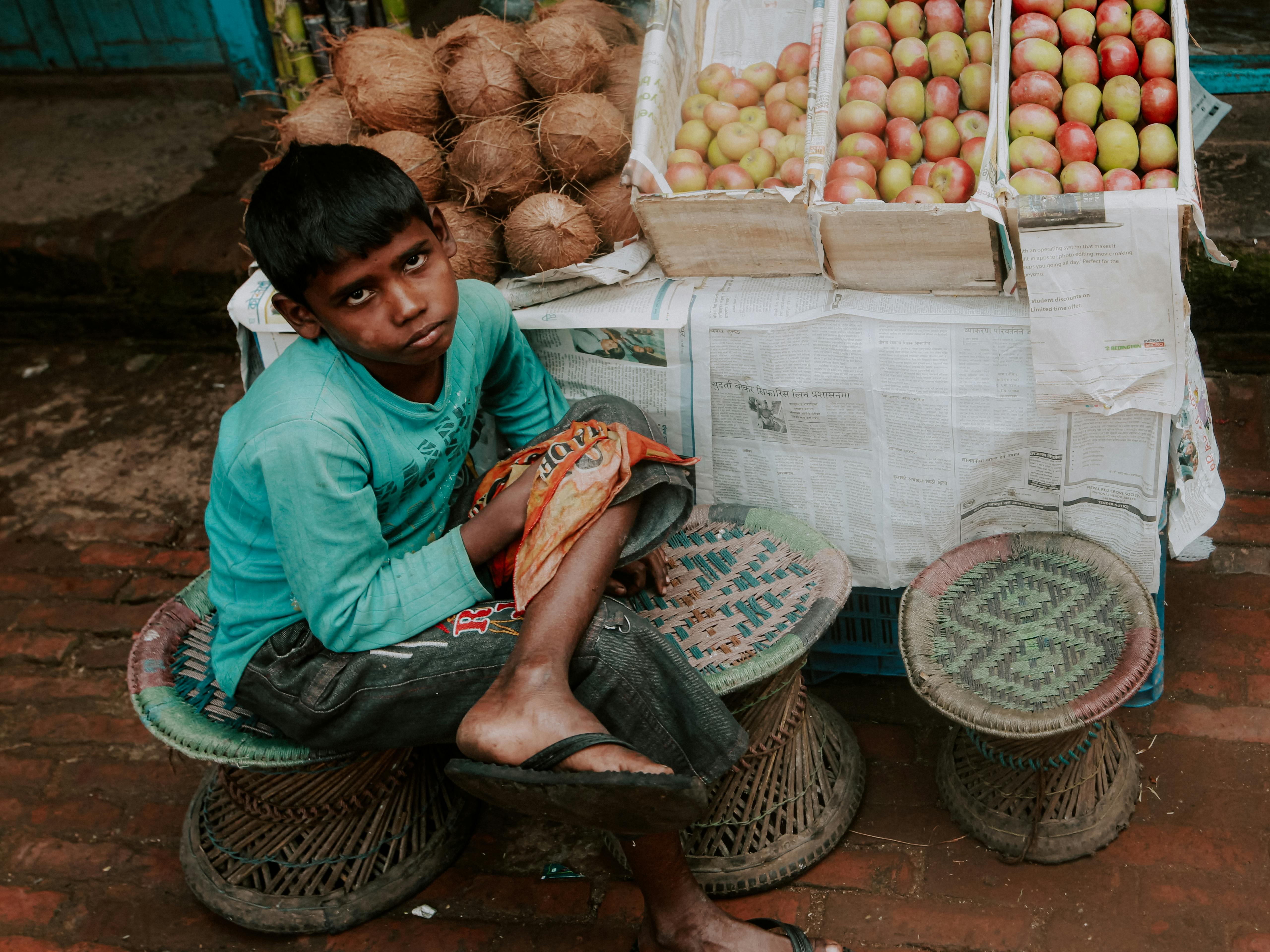 A Boy Sitting on the Street · Free Stock Photo