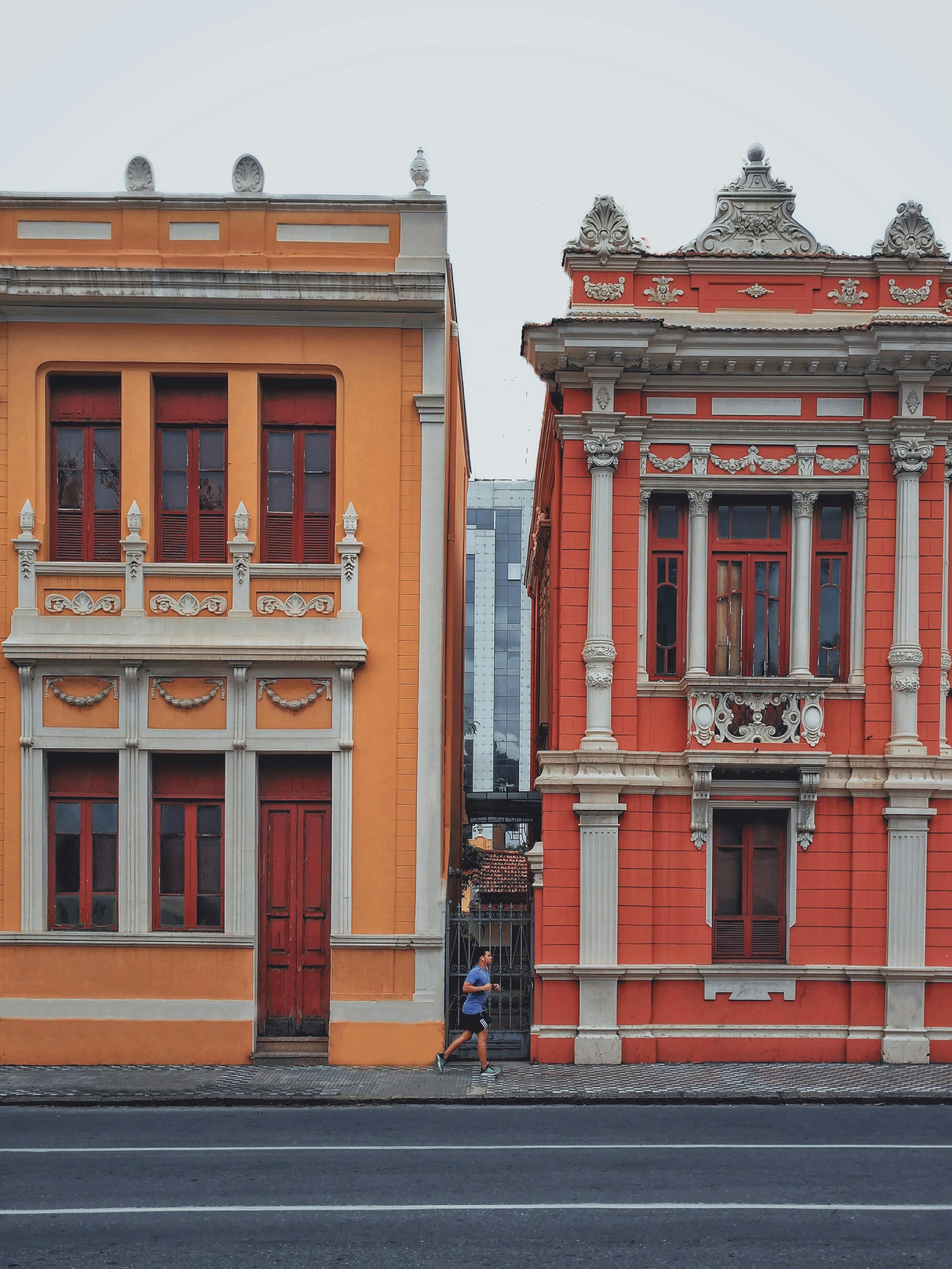 A Man Running Near the Buildings · Free Stock Photo