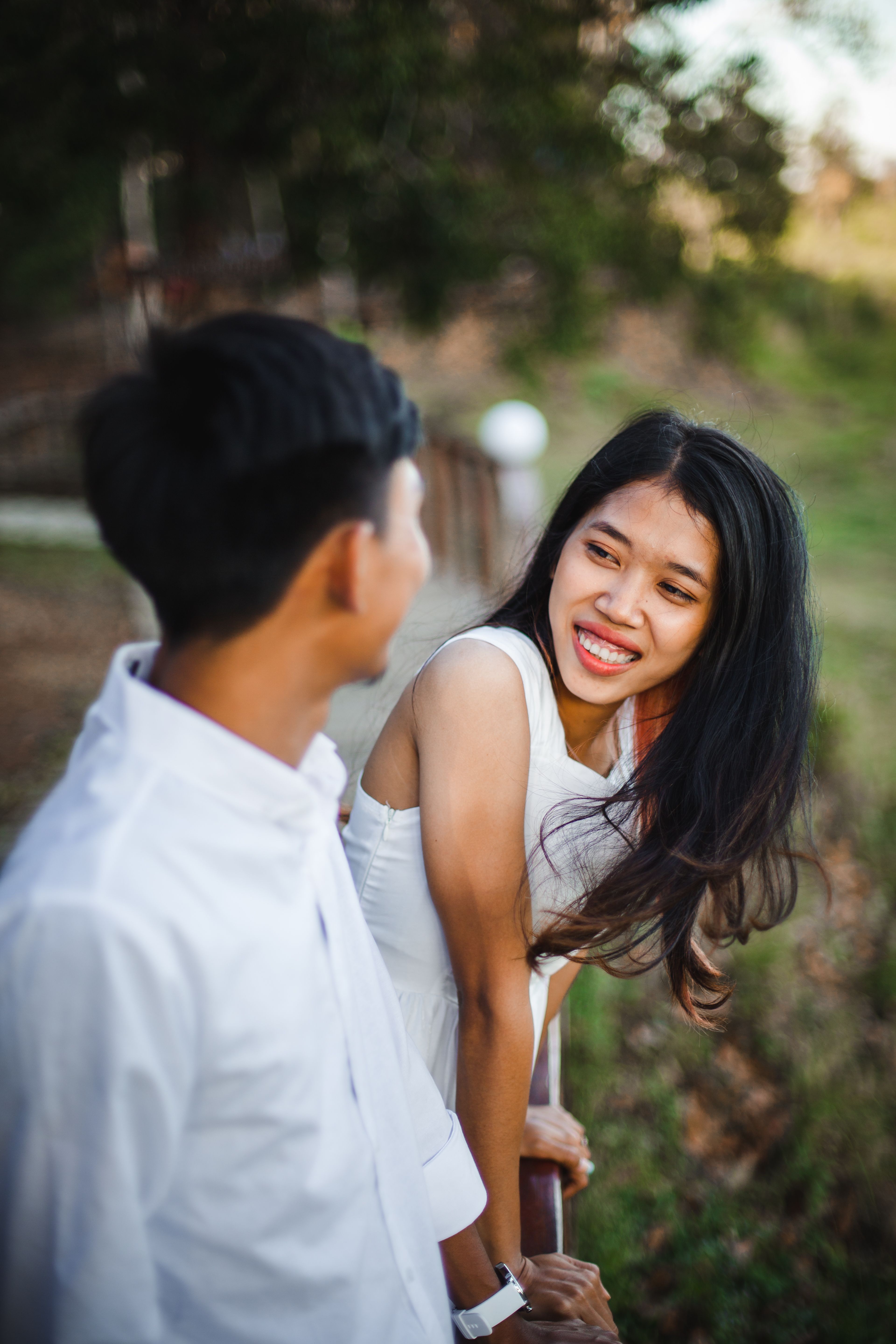 Couple Facing Each Other Smiling · Free Stock Photo