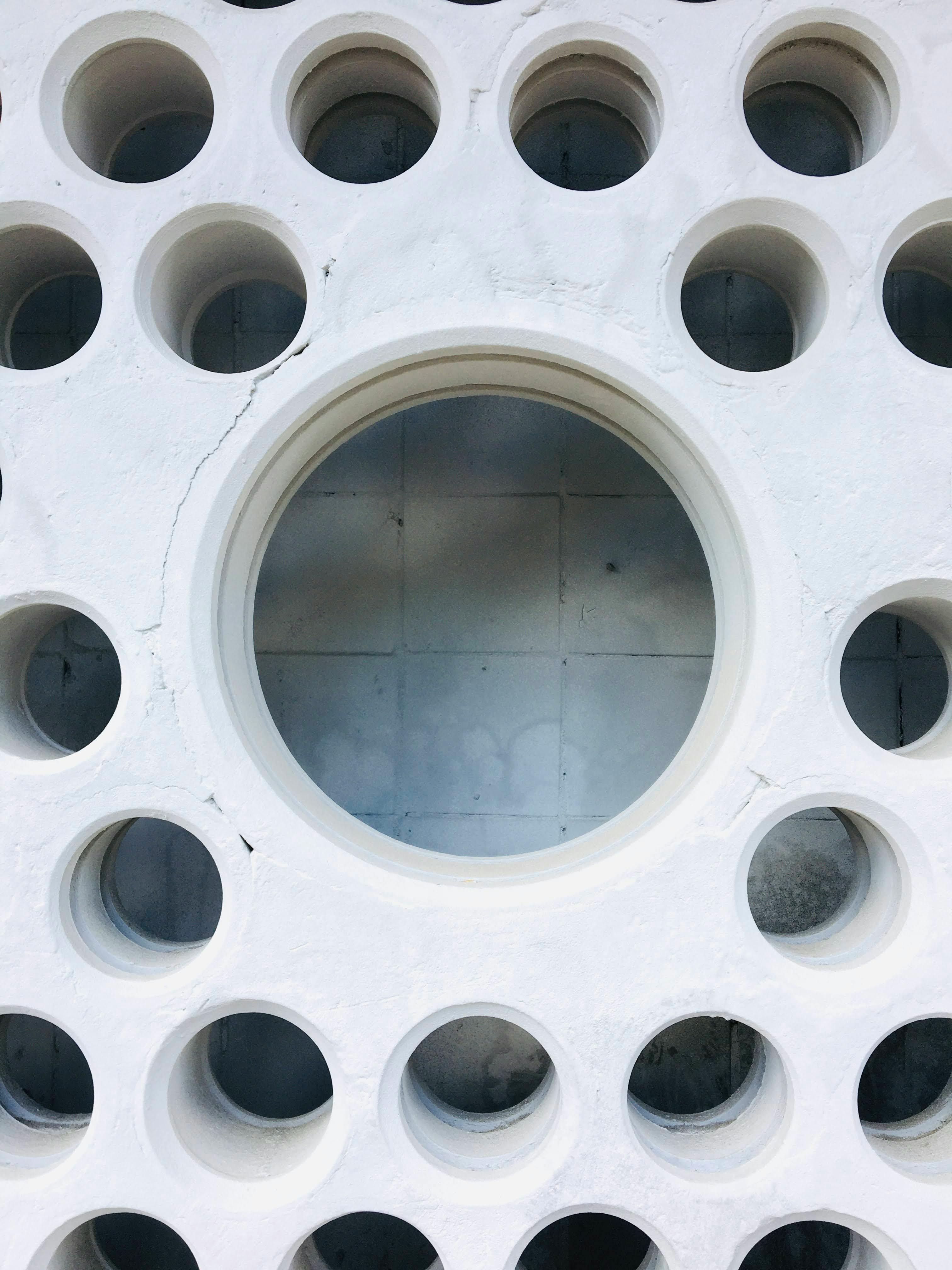 Round Holes on a Concrete Wall · Free Stock Photo