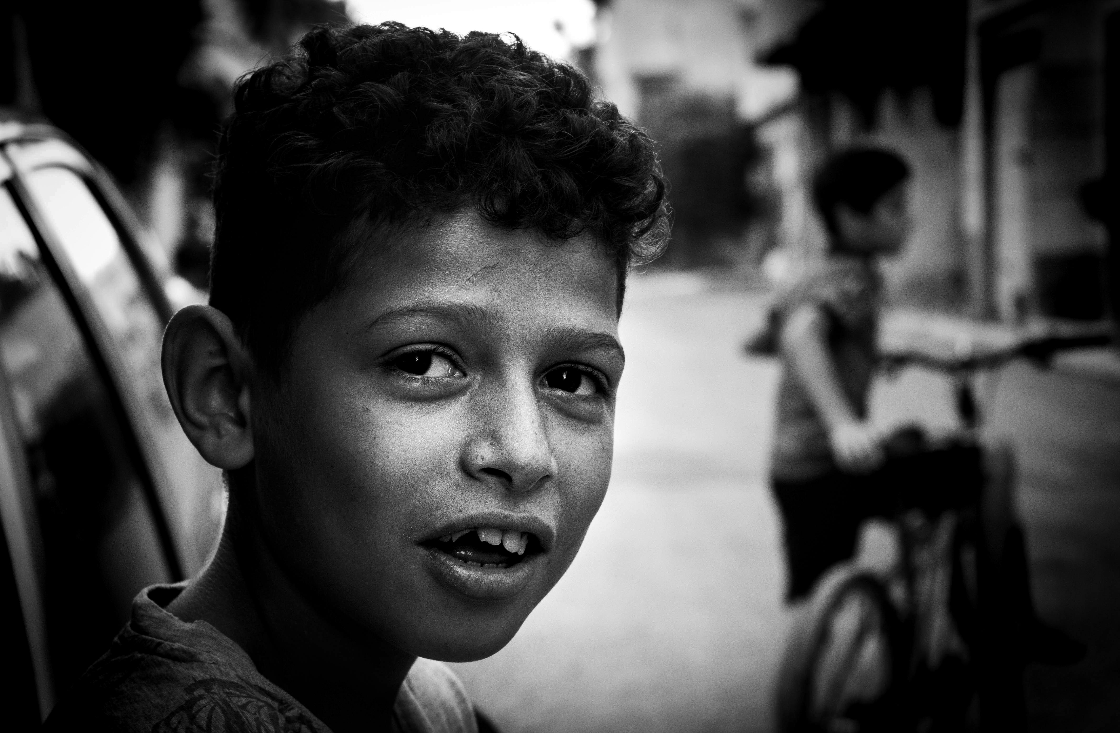 A Grayscale Photo of a Young Boy with Cream on His Face · Free Stock Photo