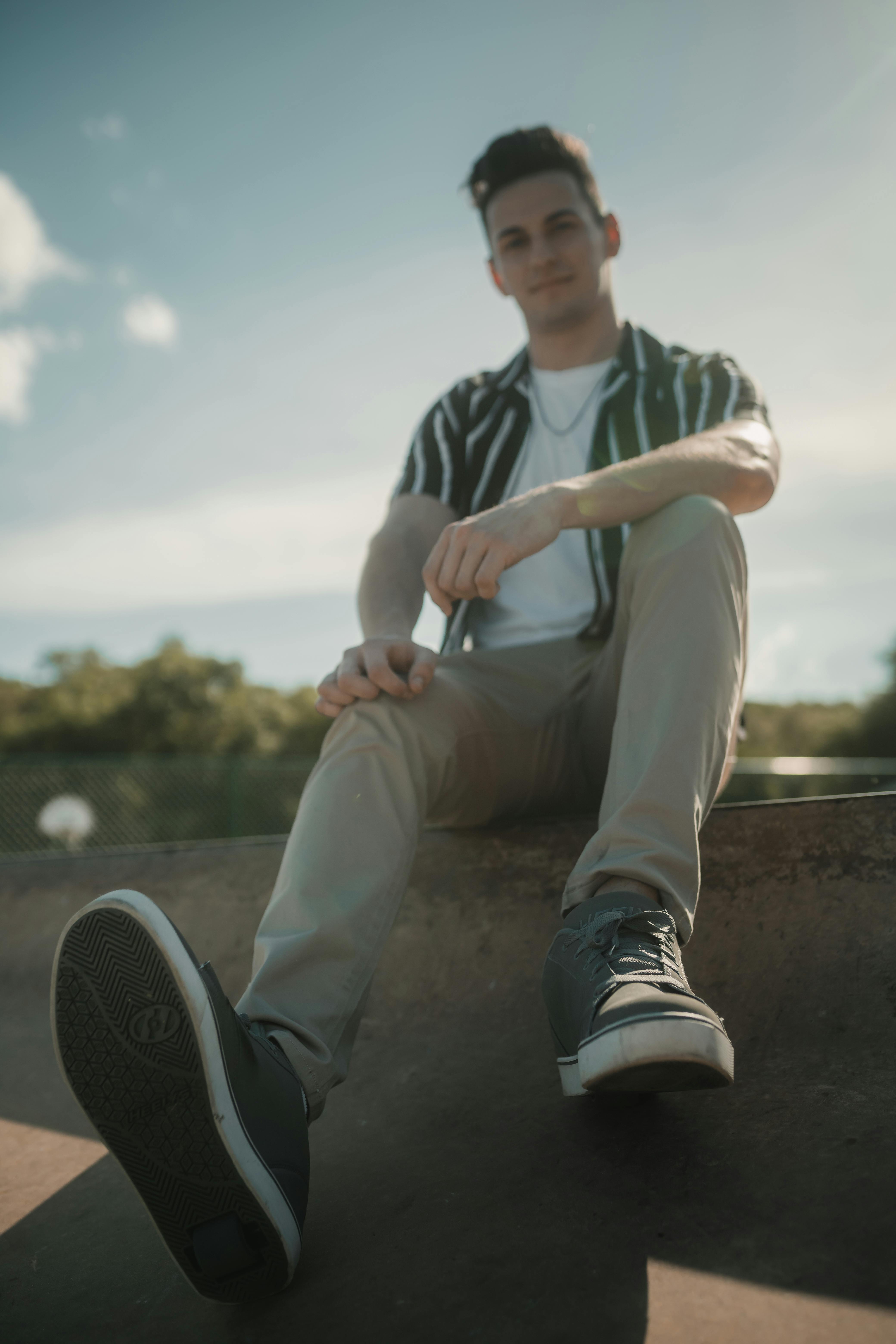 Man sitting on a Concrete Ramp · Free Stock Photo