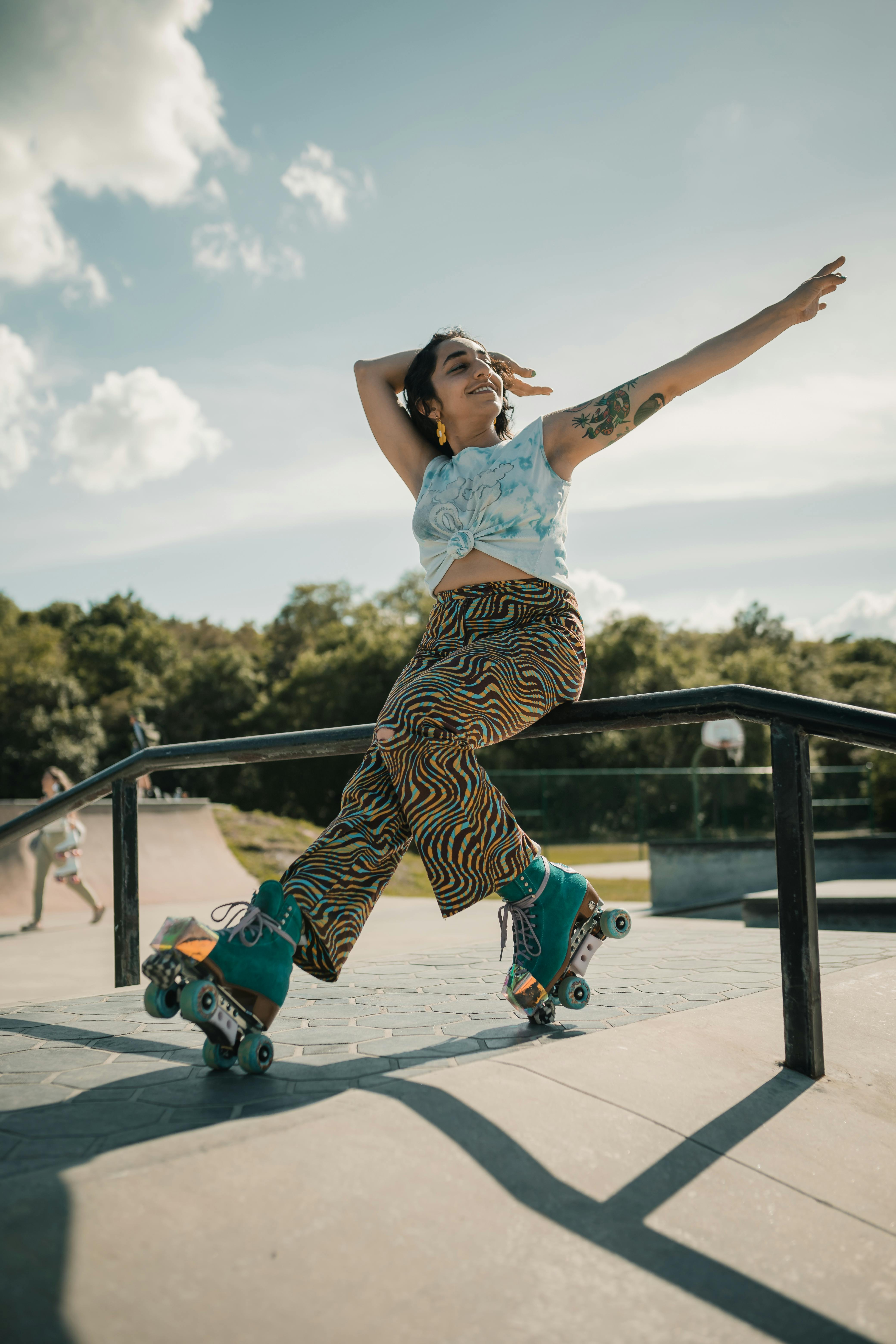 Woman in Roller Skates Sitting on Railing · Free Stock Photo