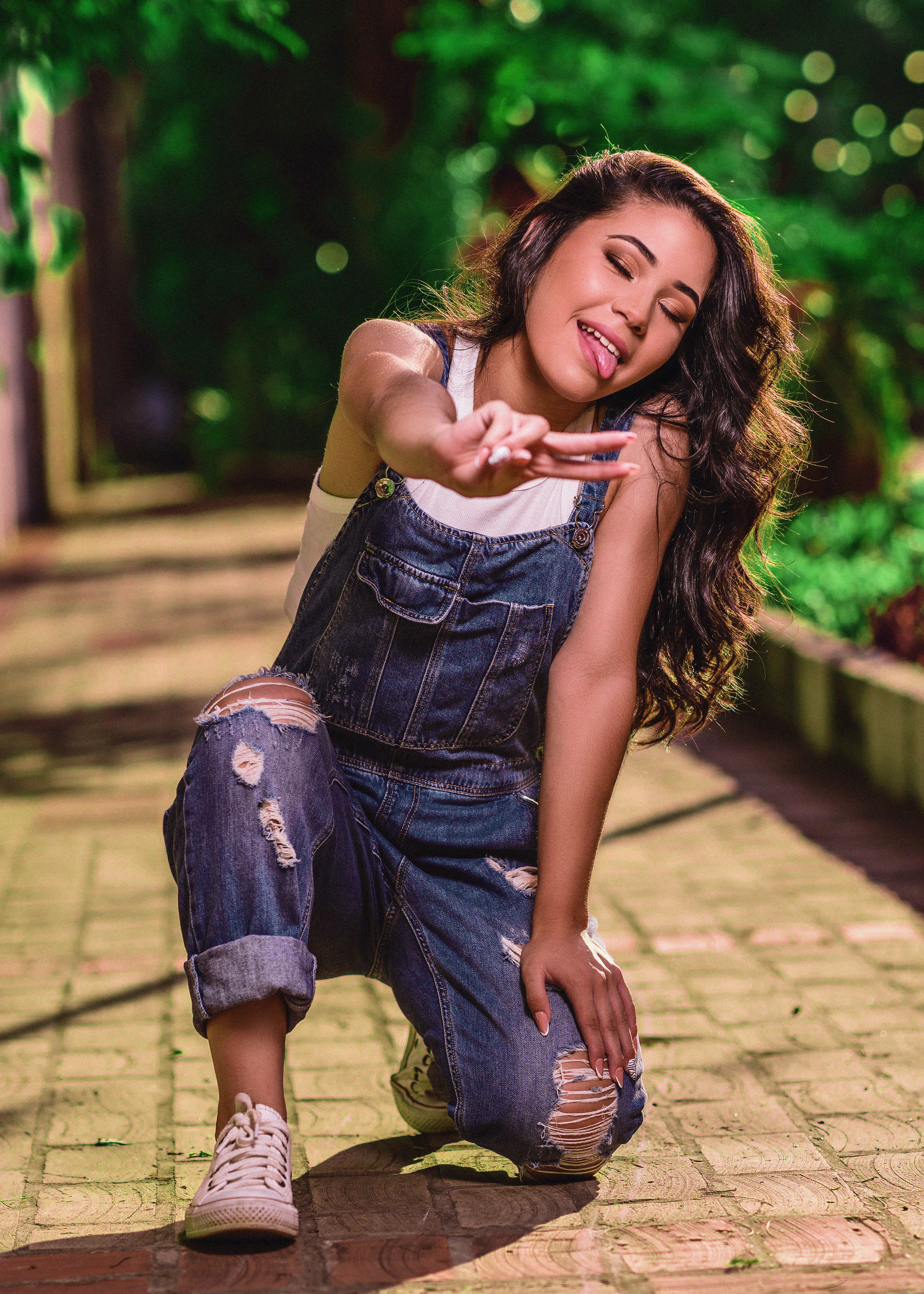 Woman in Denim Jumper Doing a Peace Sign · Free Stock Photo