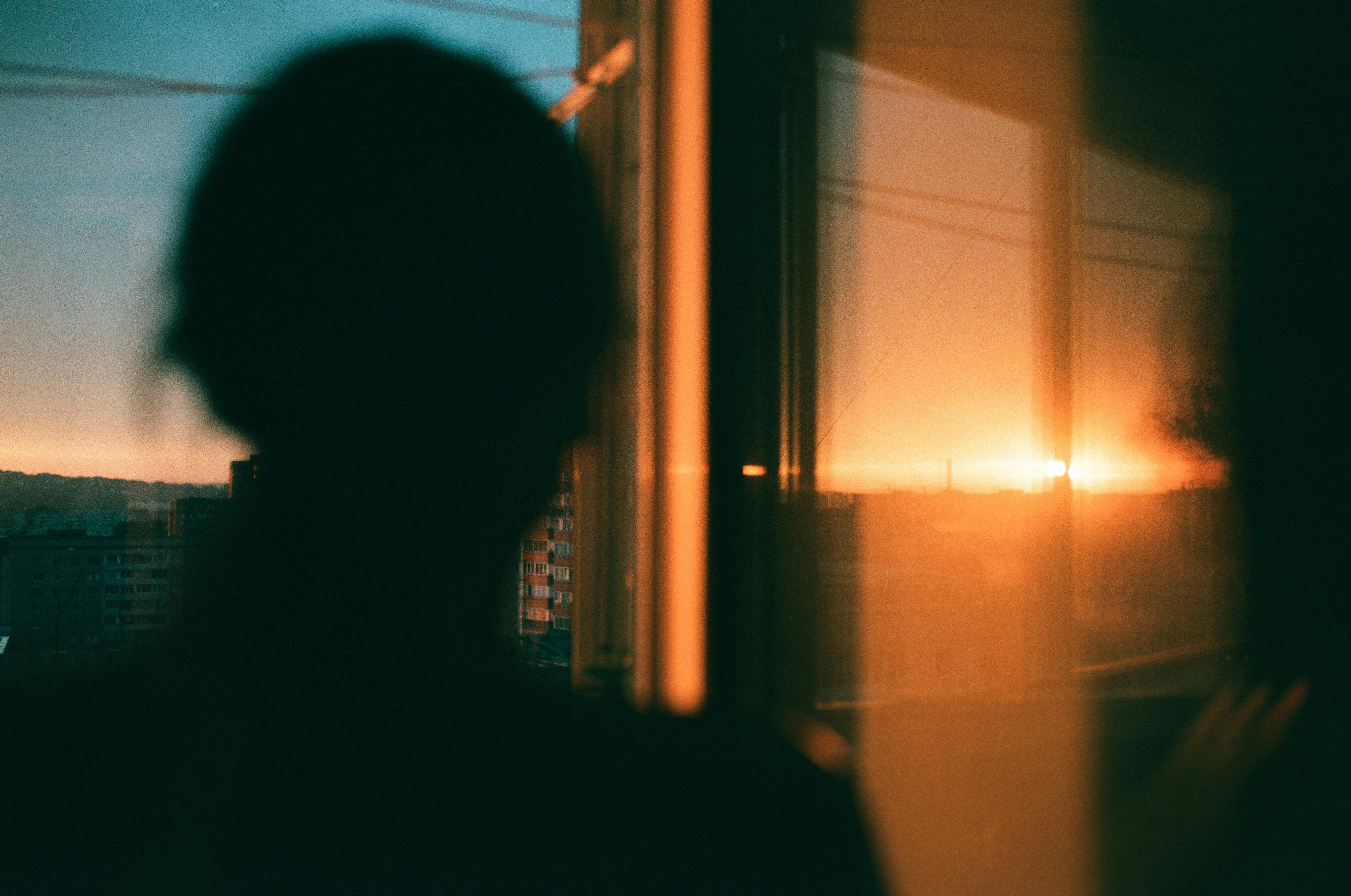 Person Standing by Window in Darkness · Free Stock Photo