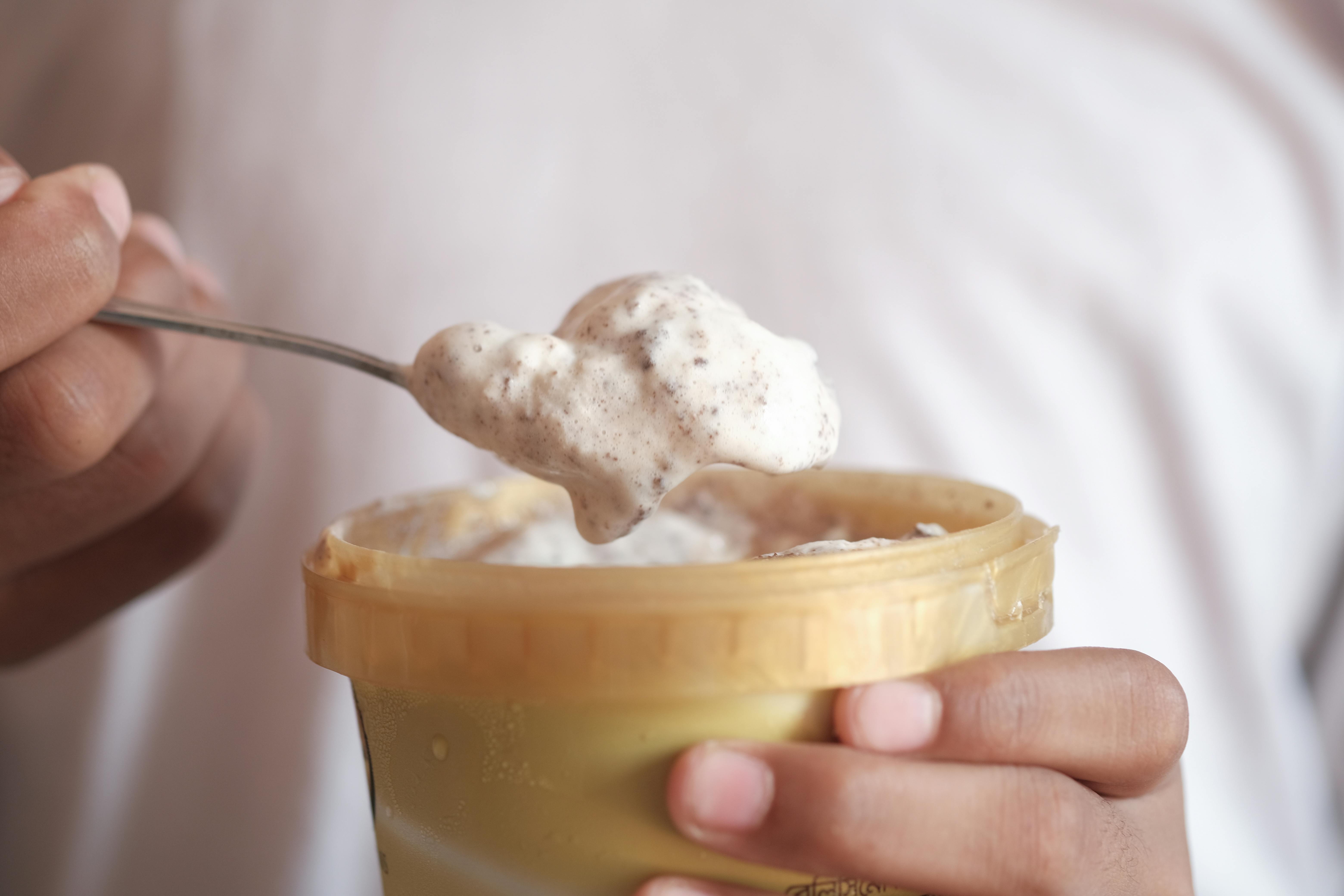 A Person Getting Ice Cream with a Spoon · Free Stock Photo