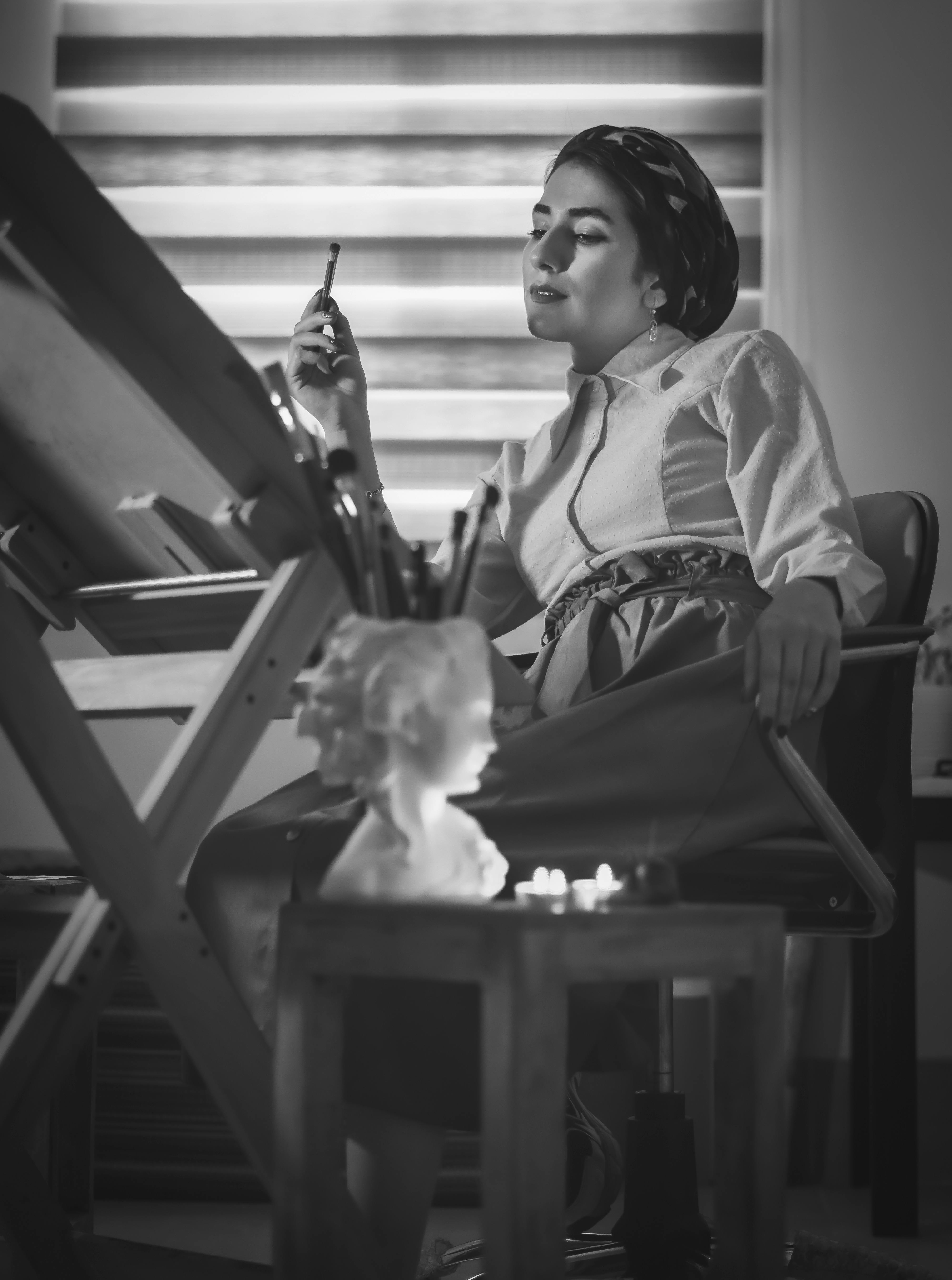 A Woman Standing in Between Artworks in Standees · Free Stock Photo