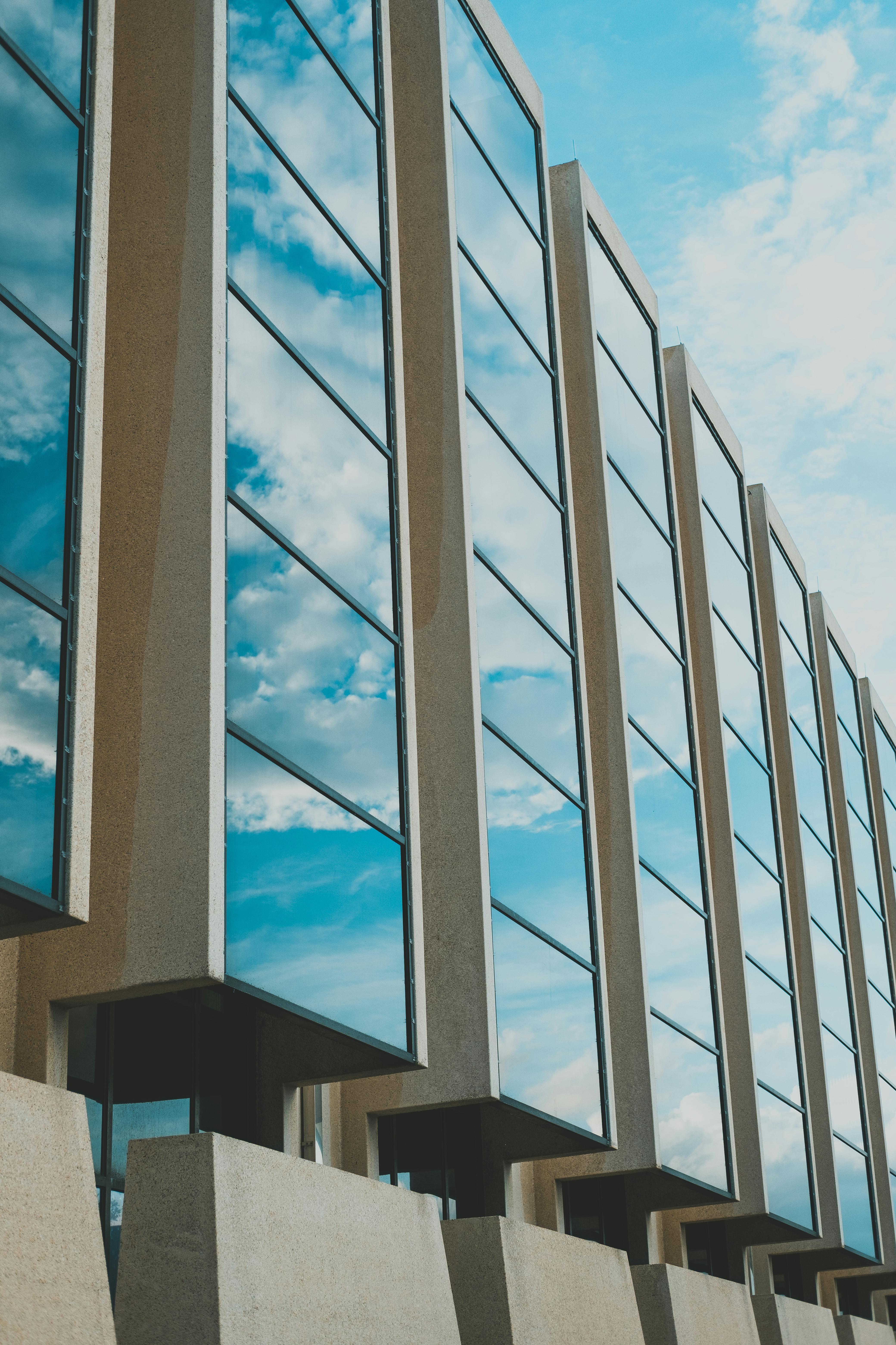 Glass Panel Windows on a Concrete Building · Free Stock Photo