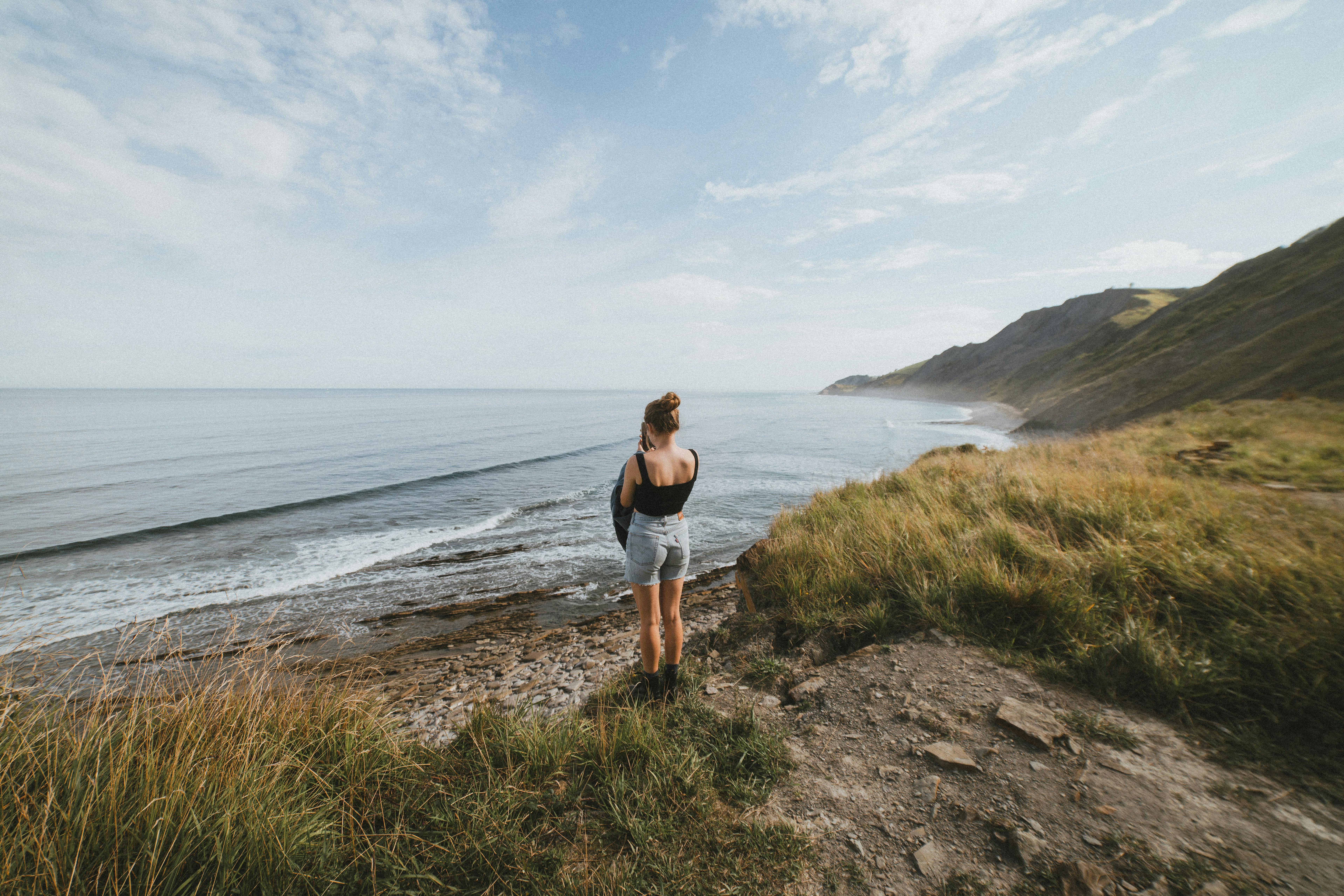 Woman Standing on Sea Shore · Free Stock Photo