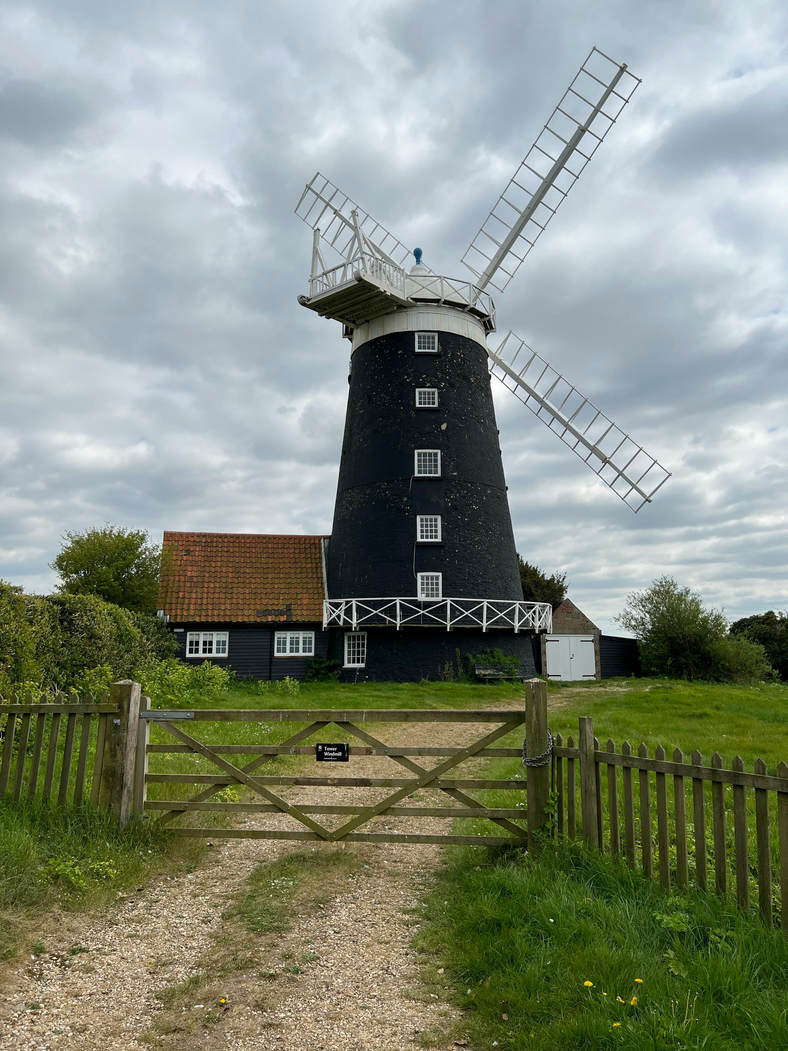 A Woman Standing Near the Brown Windmill · Free Stock Photo