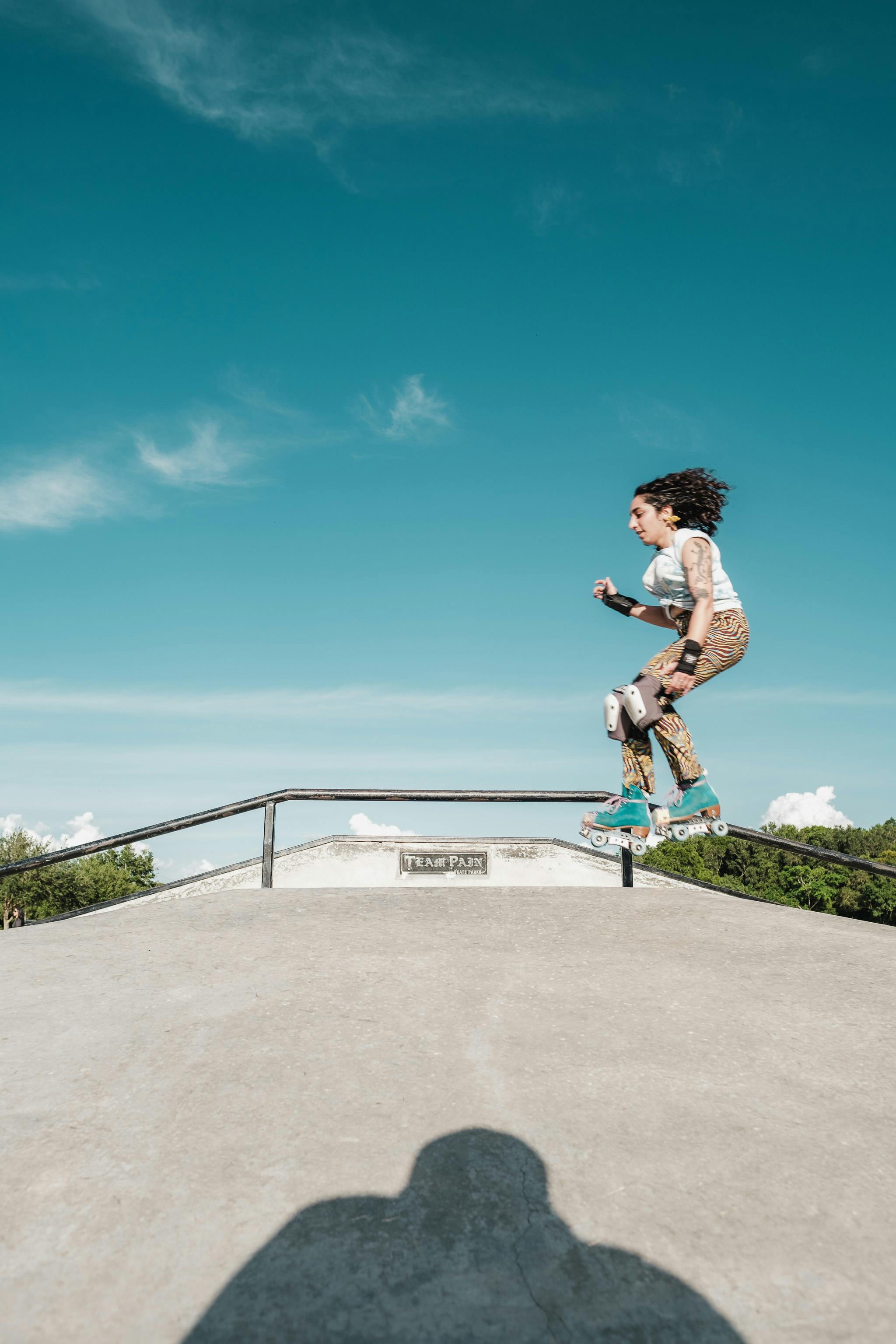 Laughing Woman Sitting on Railing at Skate Park · Free Stock Photo