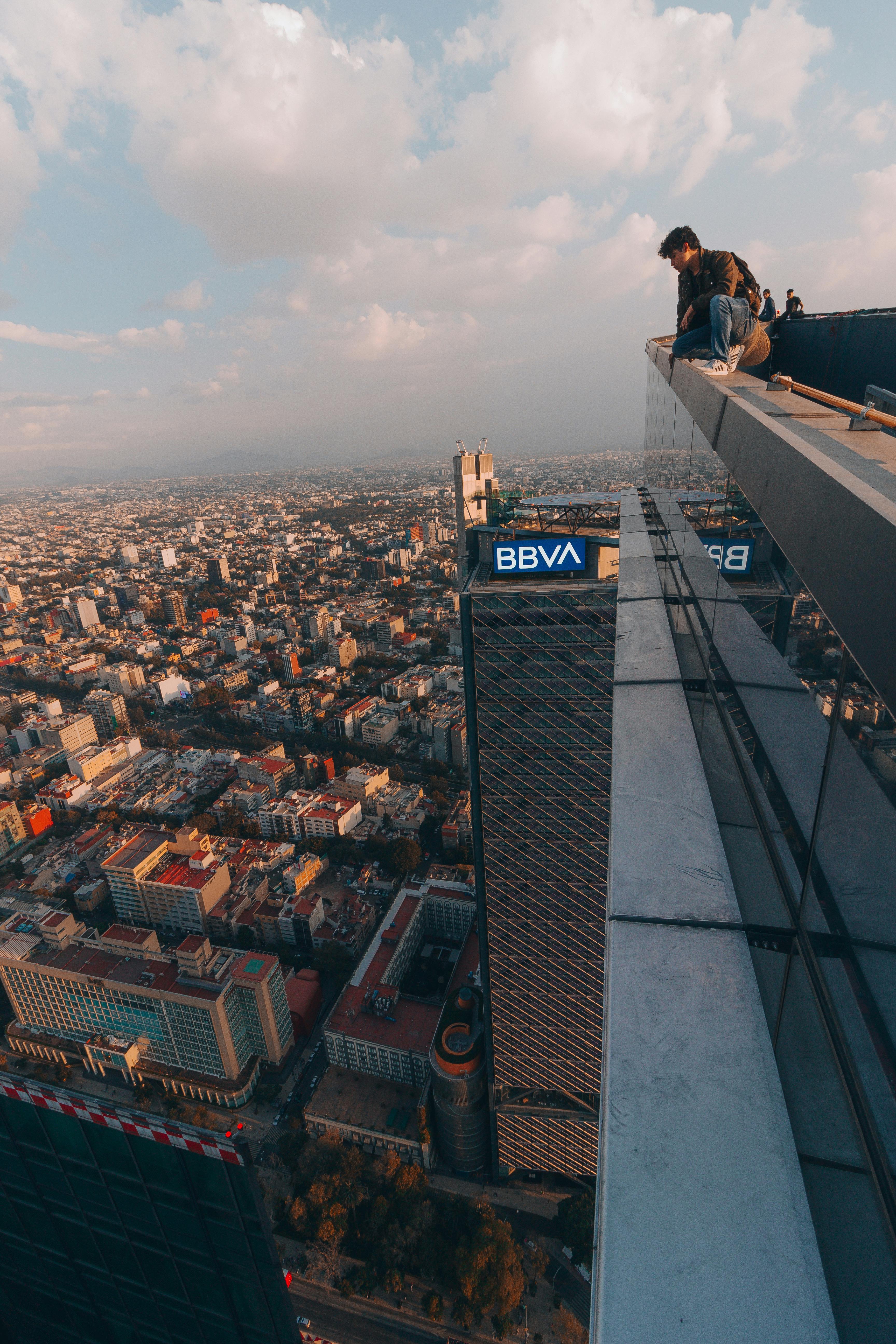 A Man Sitting on the Rooftop · Free Stock Photo