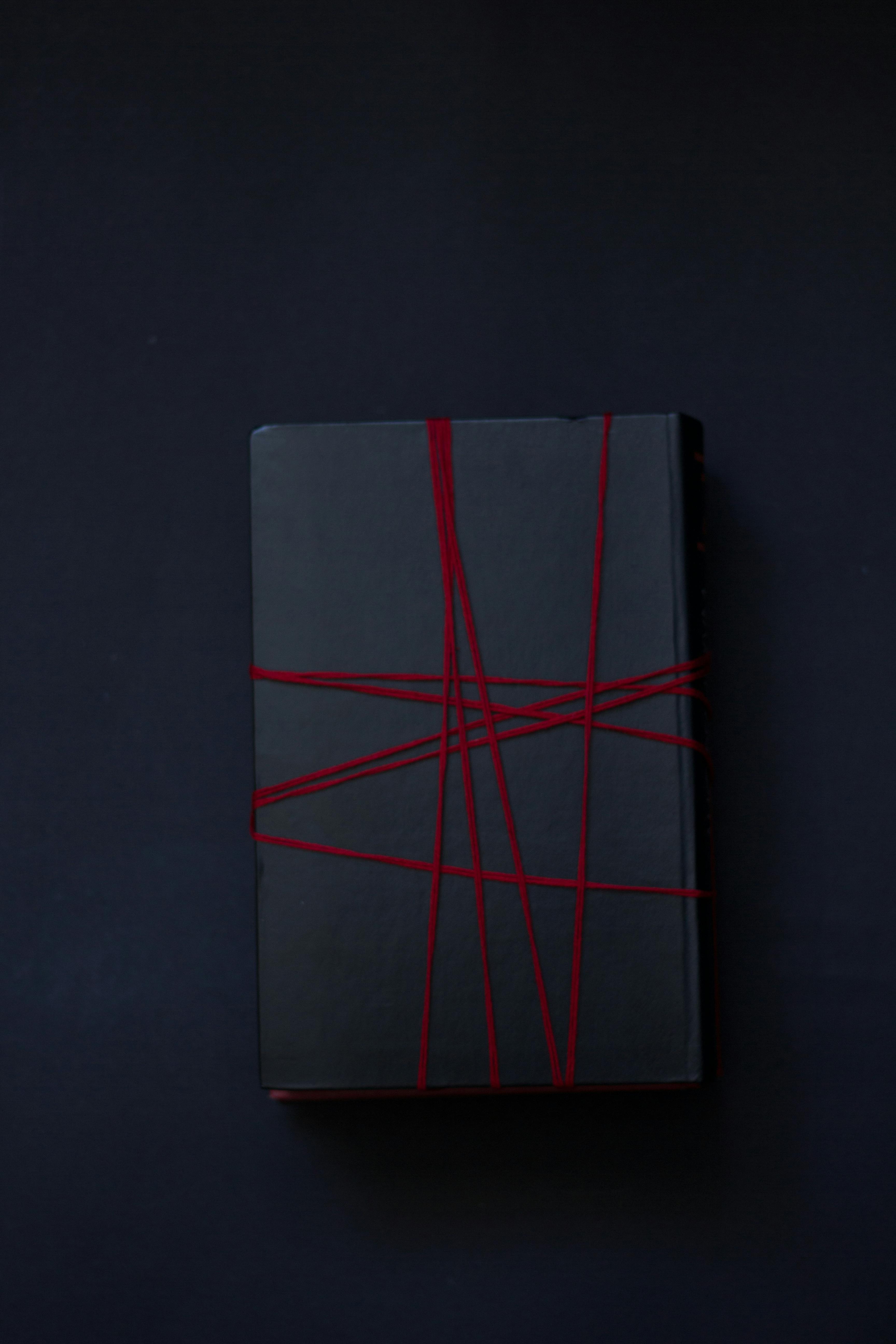 Black Book with Red Strings · Free Stock Photo