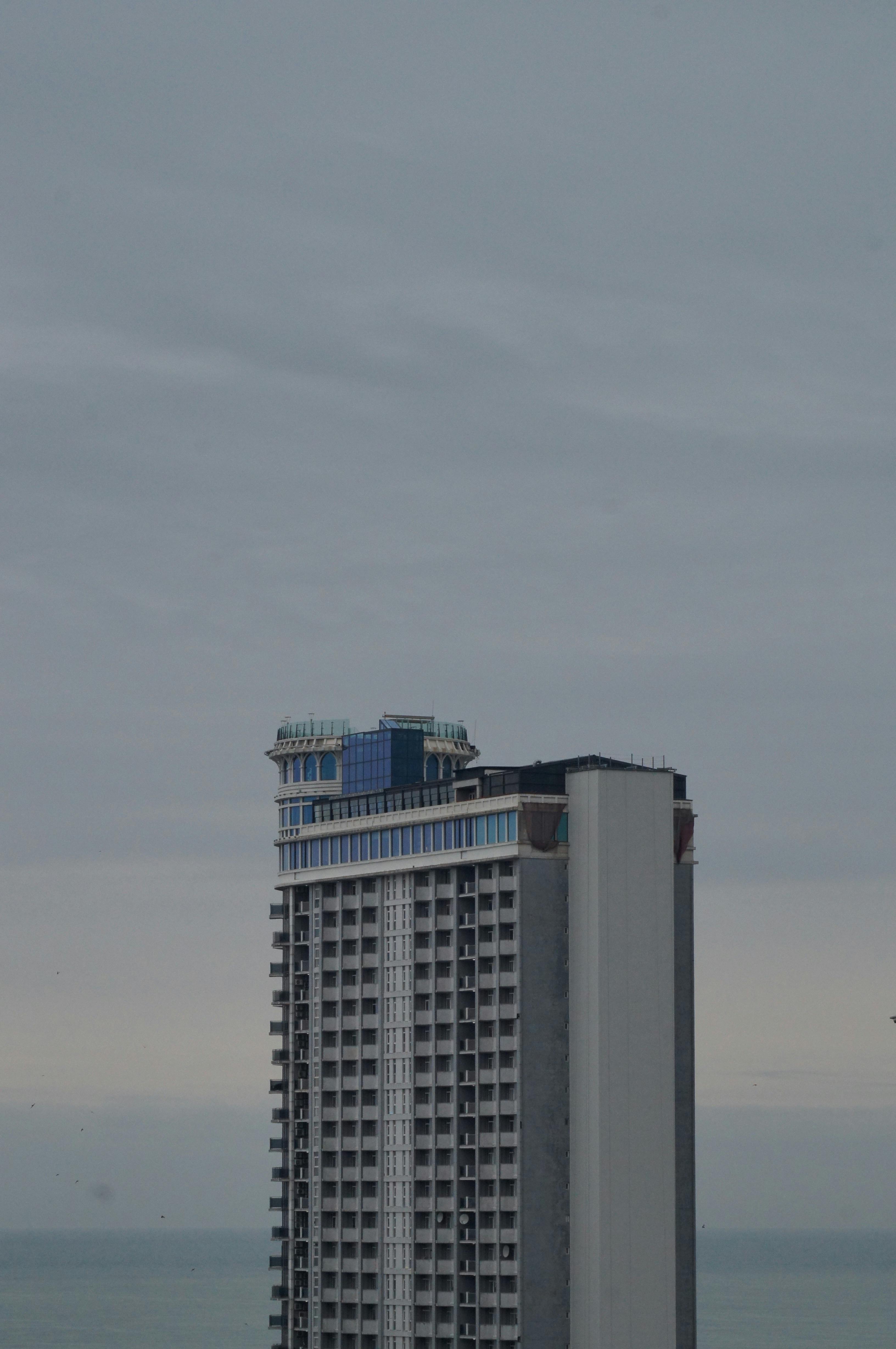 High Rise Concrete Apartment Buildings Under a Blue Sky · Free Stock Photo