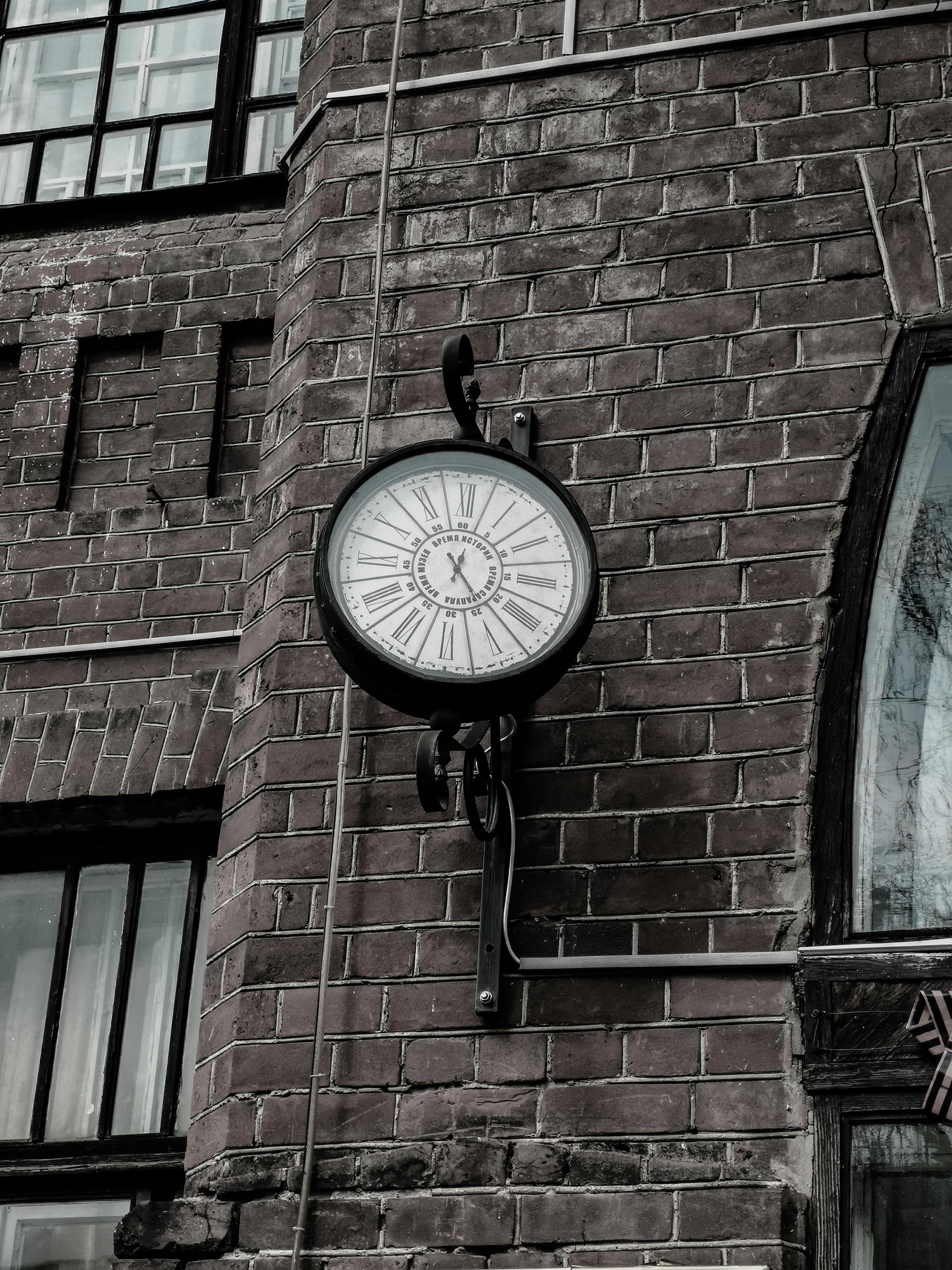 A Black and White Round Analog Wall Clock · Free Stock Photo