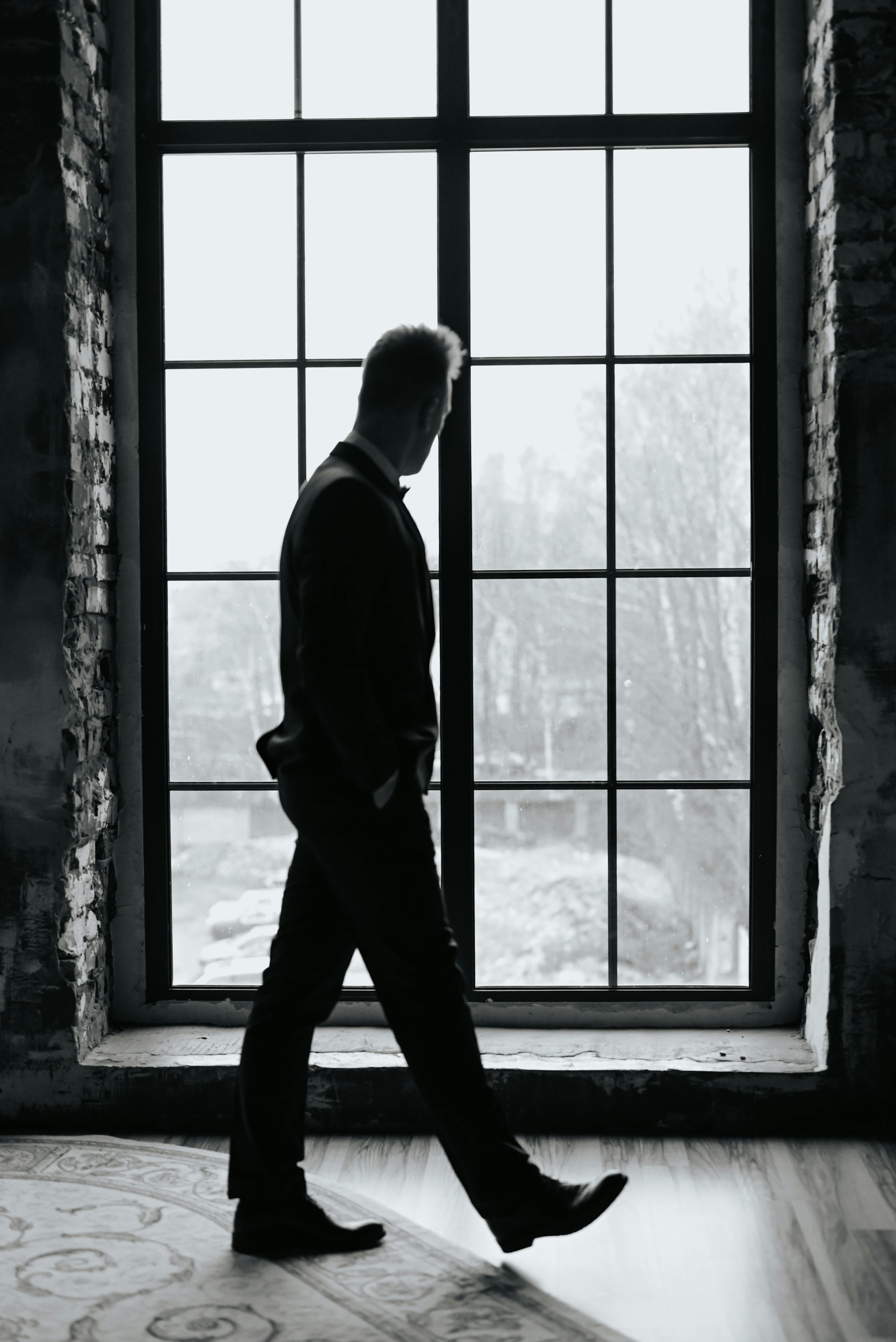 Walking People behind Gaps between Windows and Post · Free Stock Photo