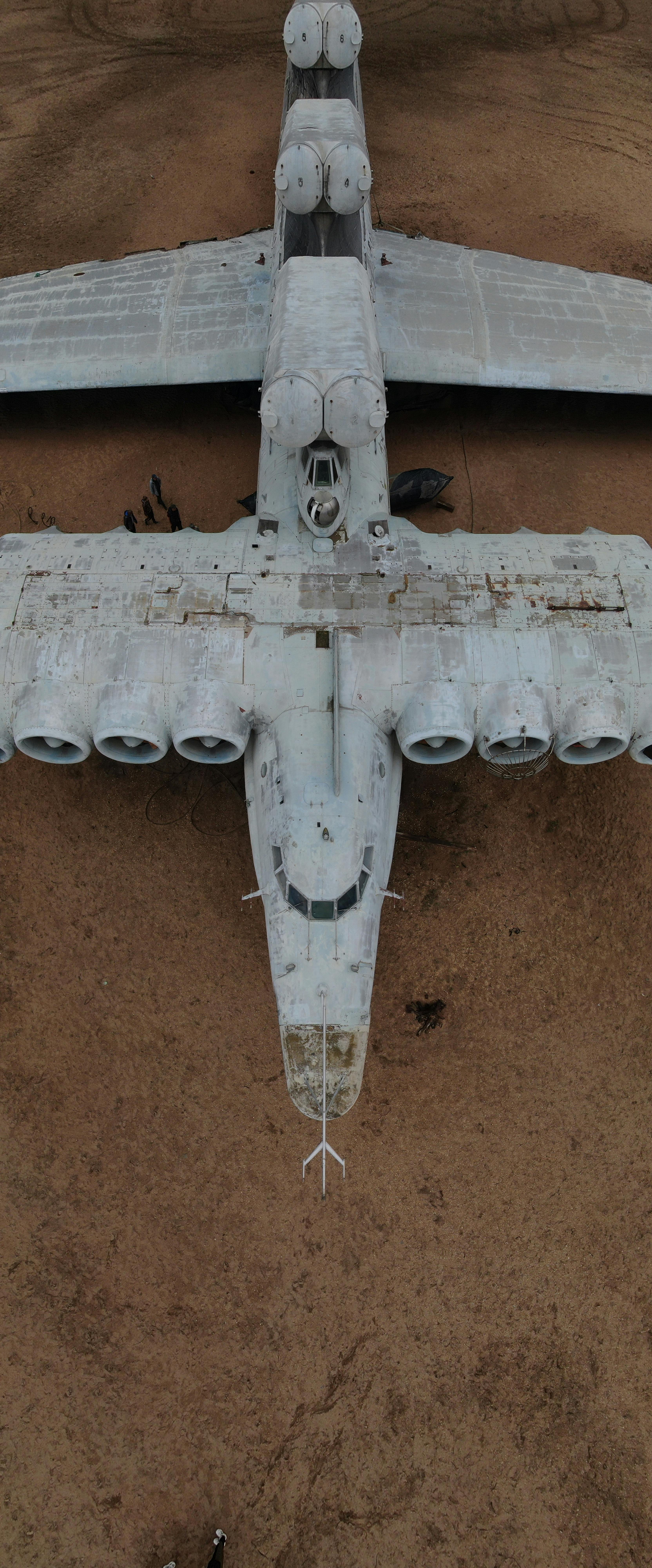 High Angle View of a Weathered Airplane Model on Sand · Free Stock Photo