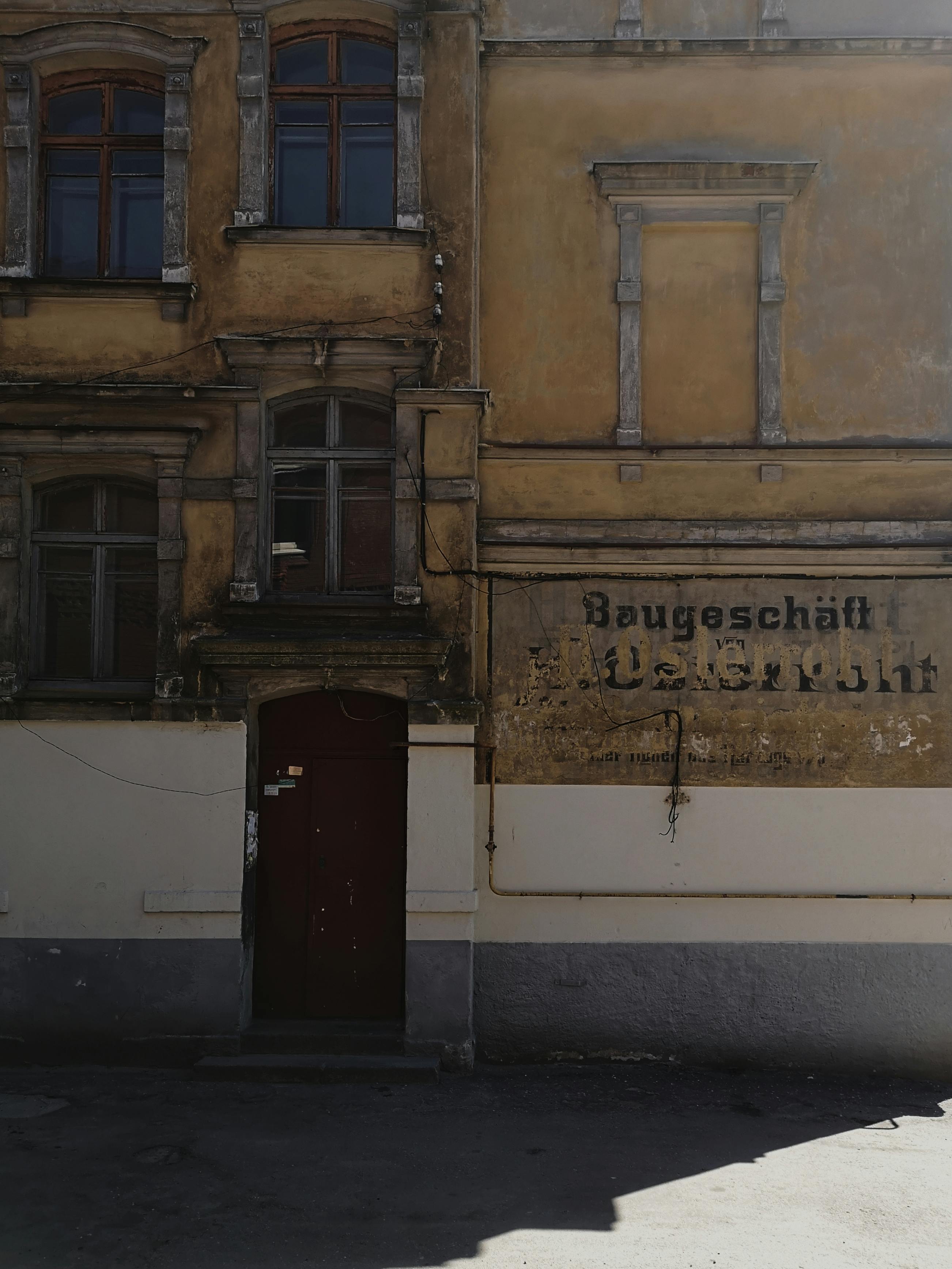 Exterior of an Old Tenement House with German Writing · Free Stock Photo