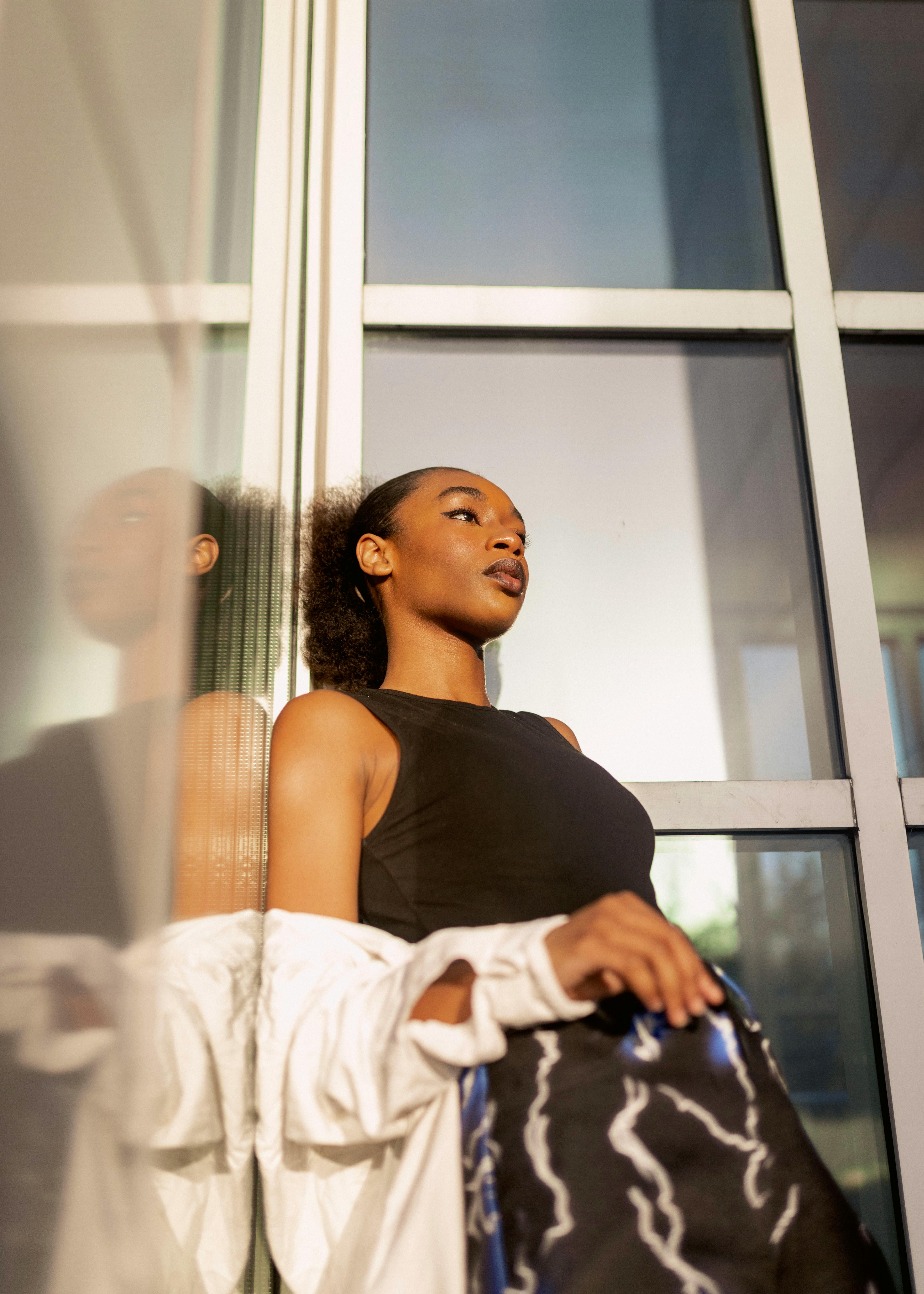 Woman Leaning Against Window · Free Stock Photo