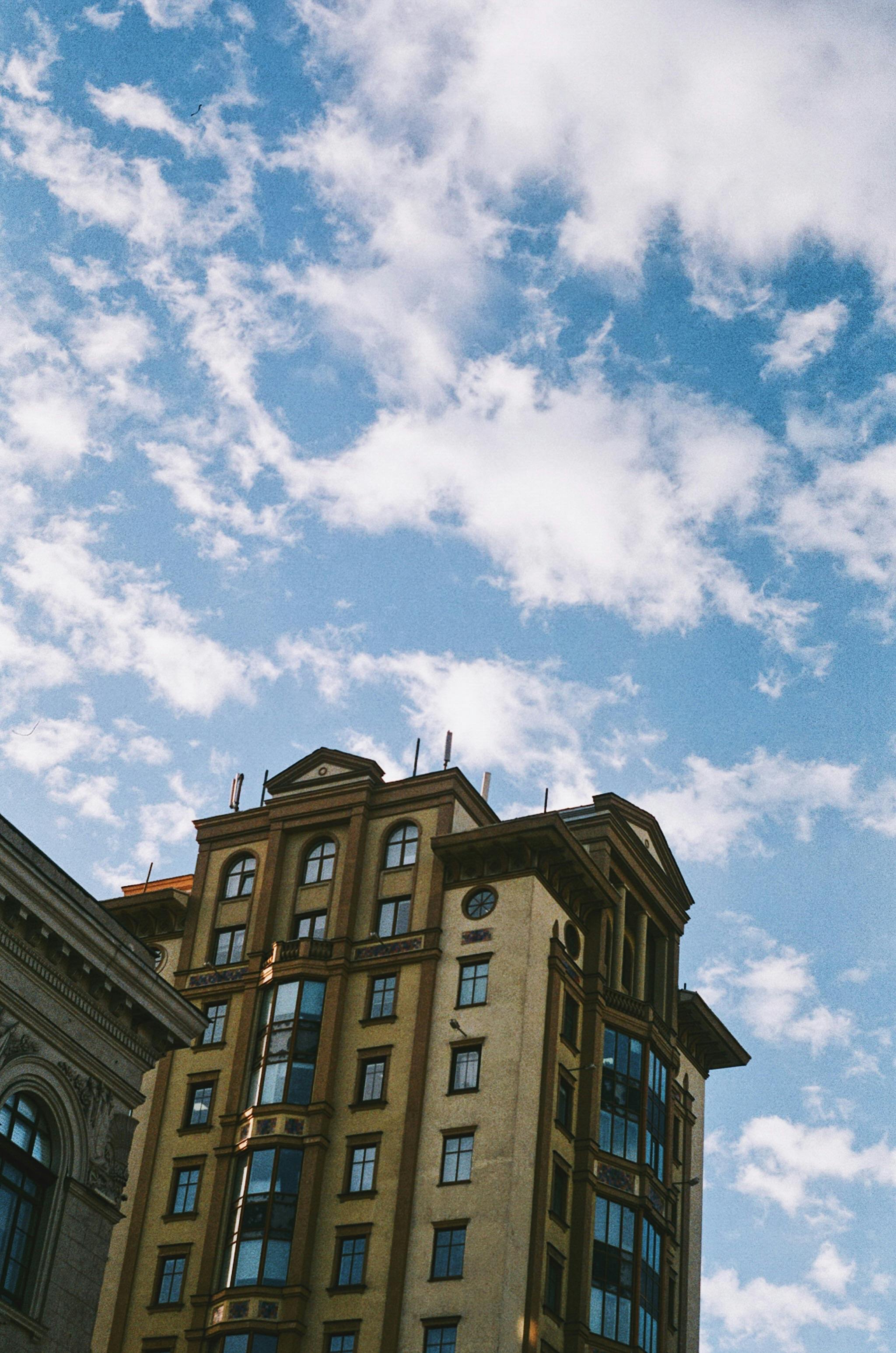 Classic Apartment Building against Blue Sky · Free Stock Photo