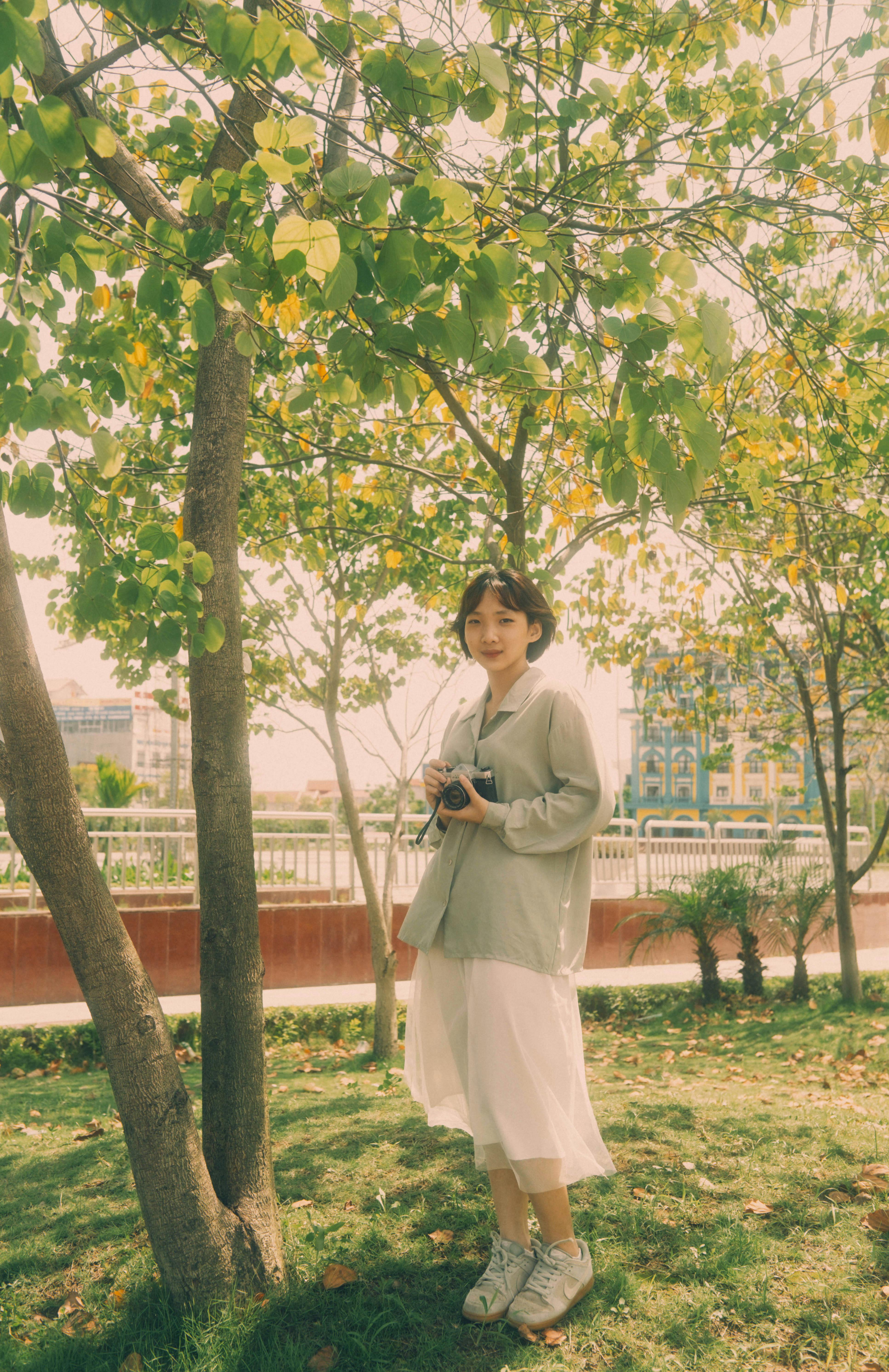 Woman Standing among Trees in Park · Free Stock Photo