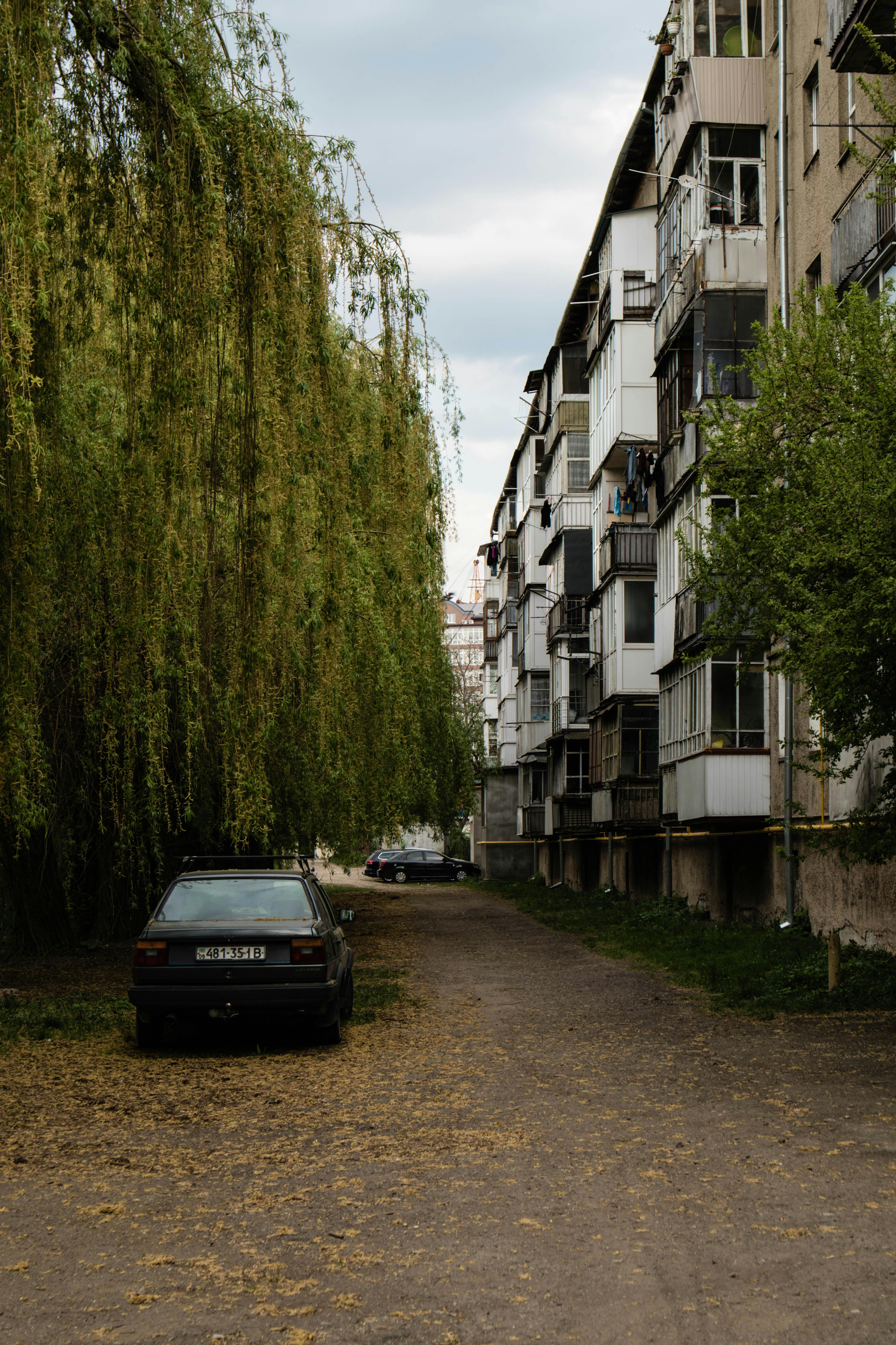 A Car Parked on a Street Beside a Building · Free Stock Photo