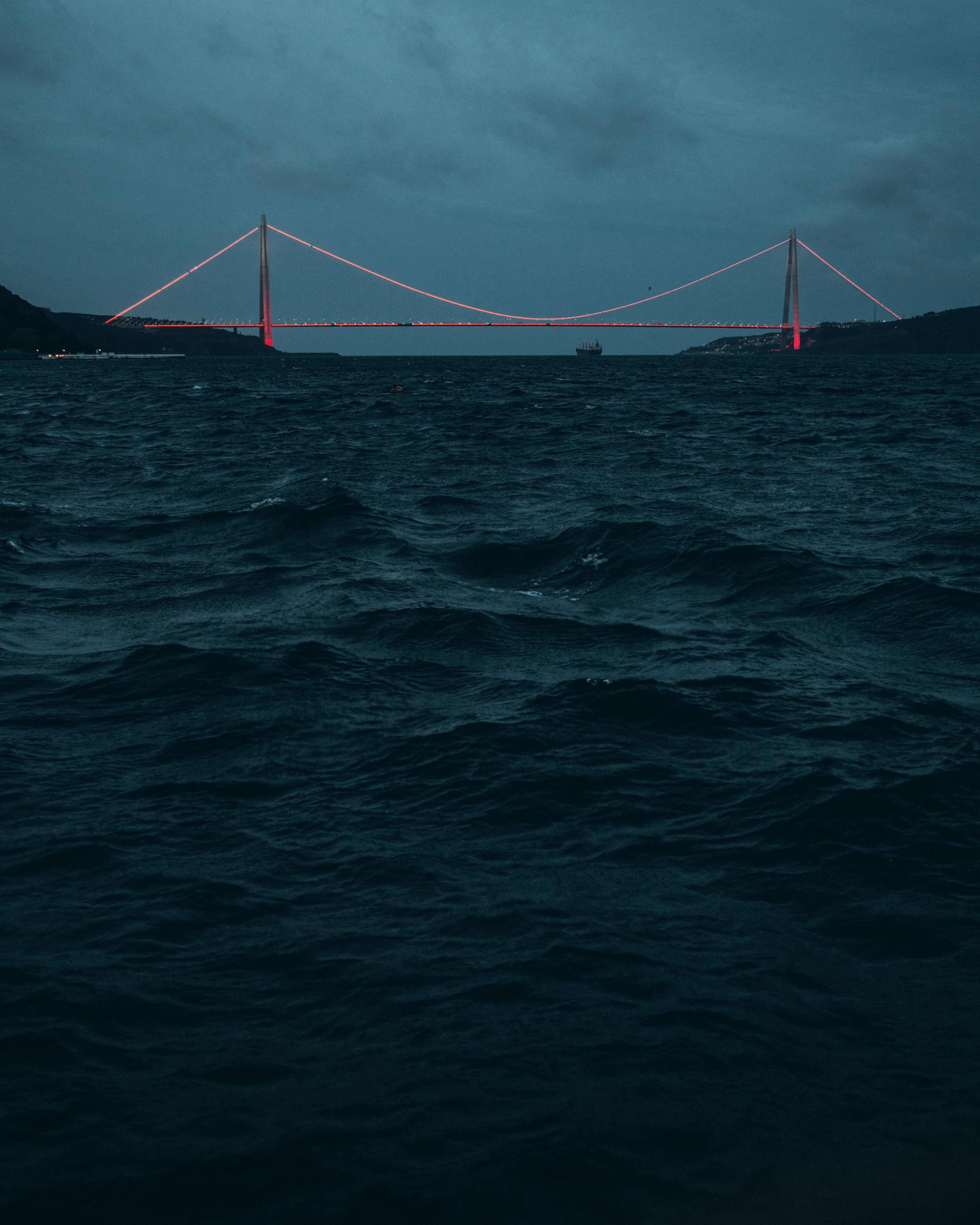 A Bridge Under a Dark Sky and Water · Free Stock Photo