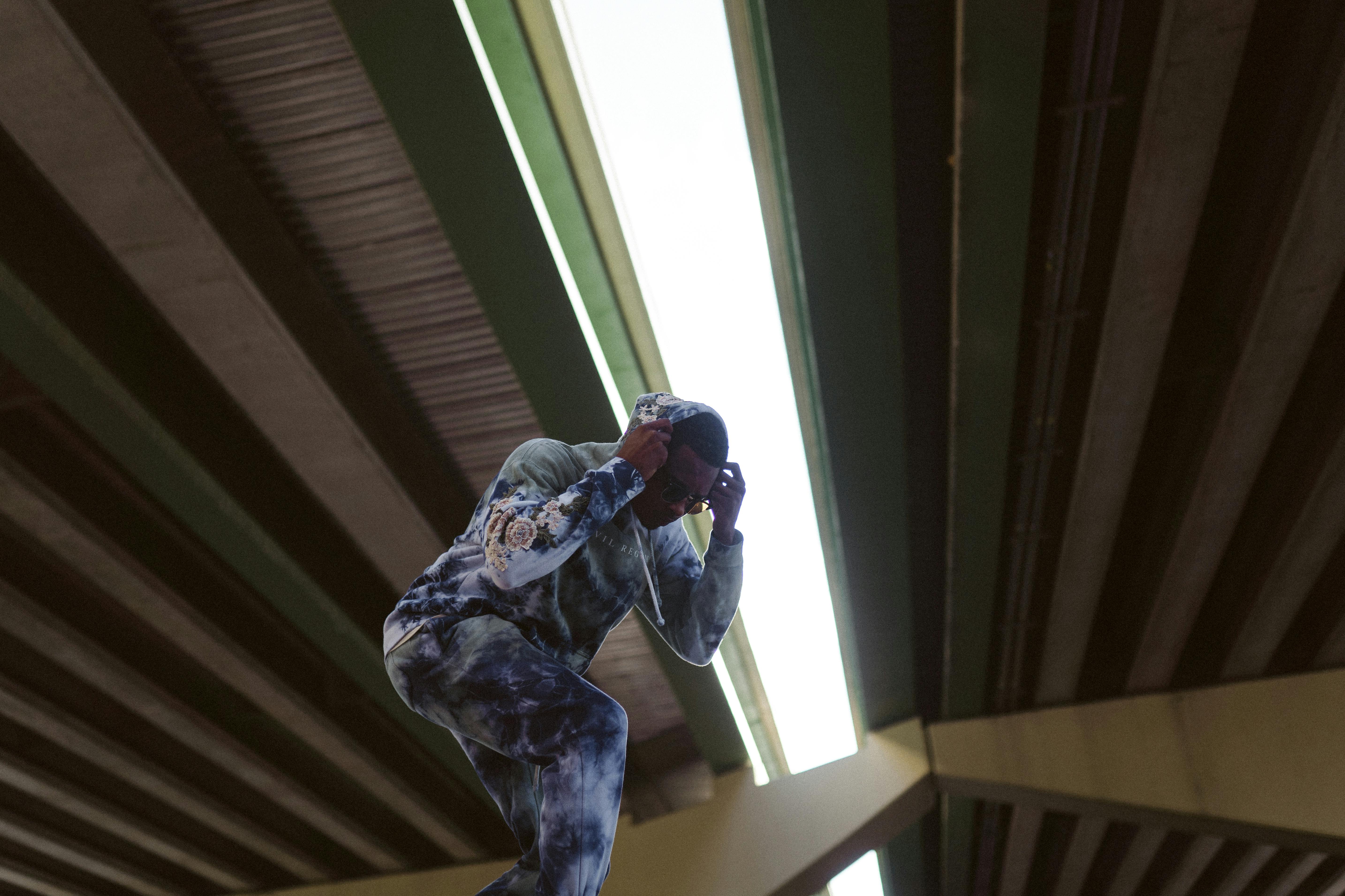 A Man Running on a Concrete Bench Near Pigeons · Free Stock Photo