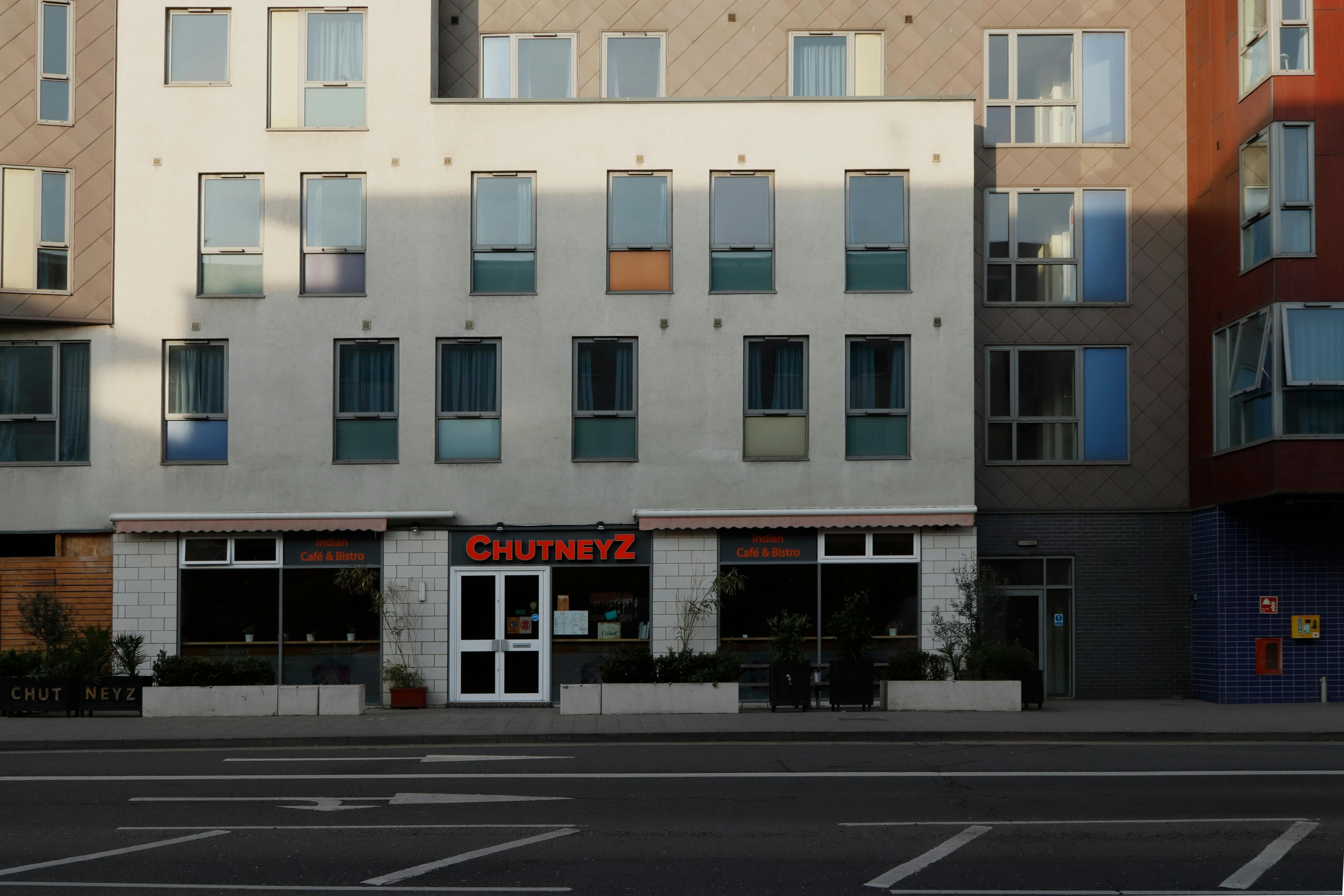 Tim Hortons Neon Signage Over Doors of a Building · Free Stock Photo