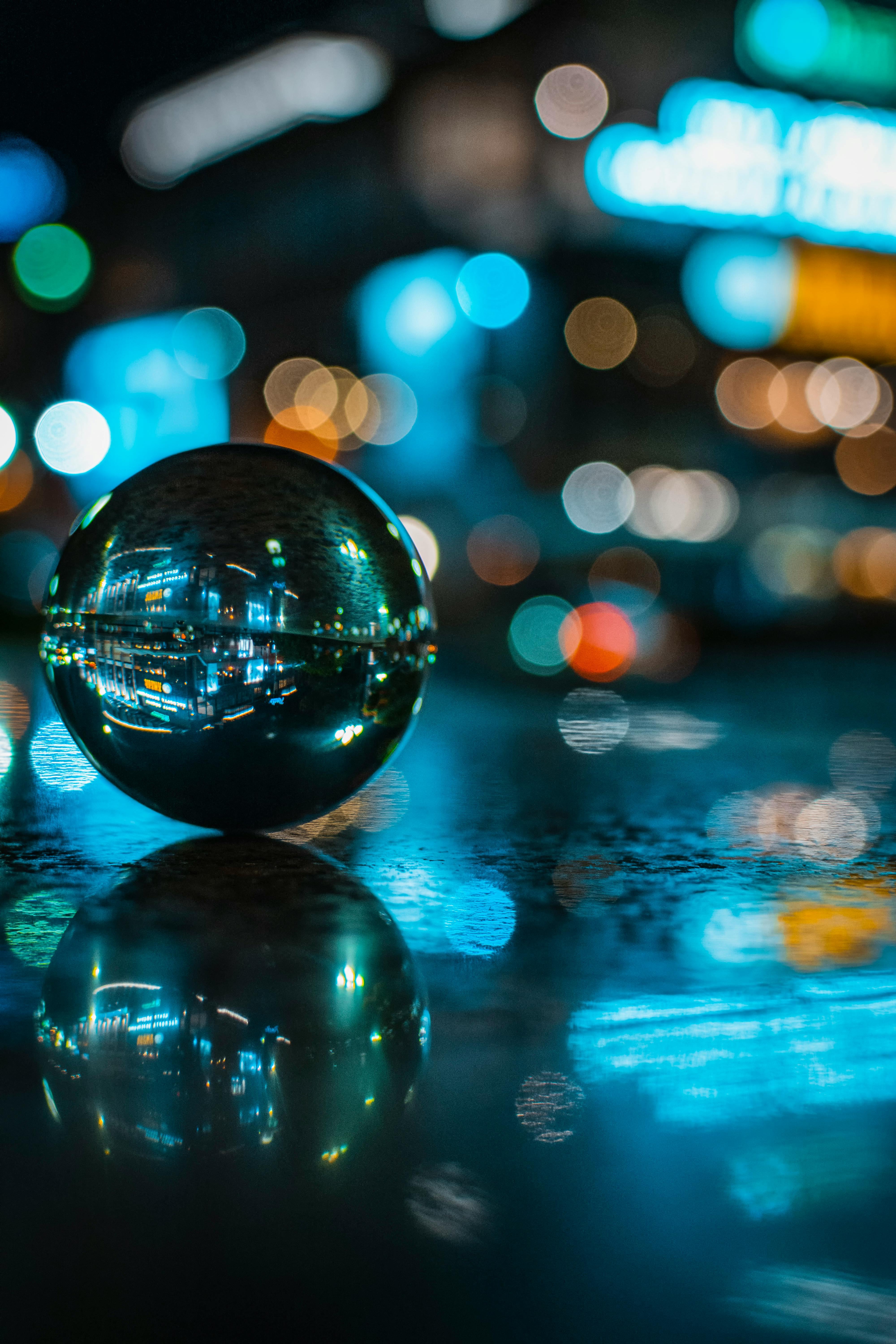 Glass Ball With Reflection of Lighted Building · Free Stock Photo