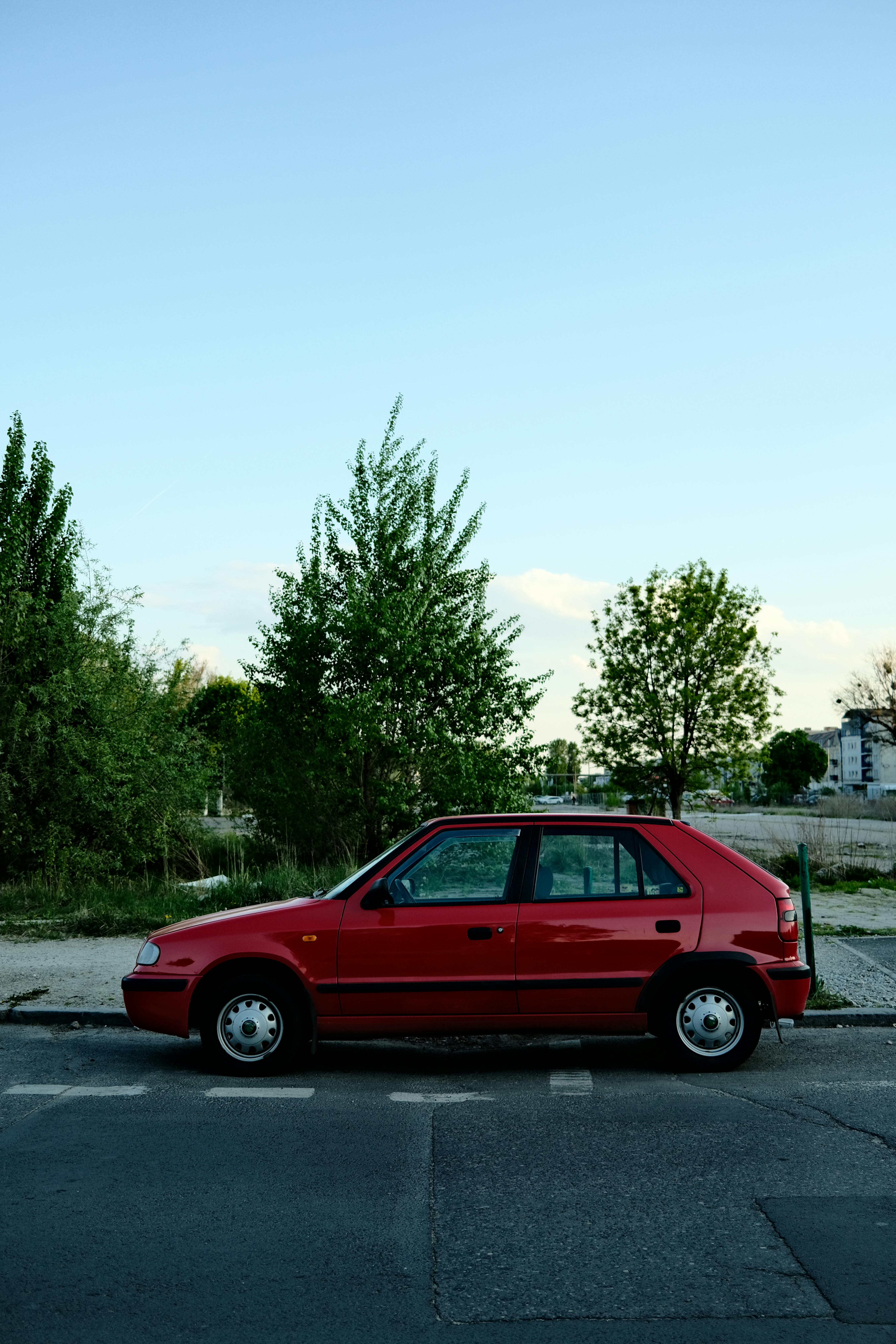 Red Car Parked Beside Trees · Free Stock Photo