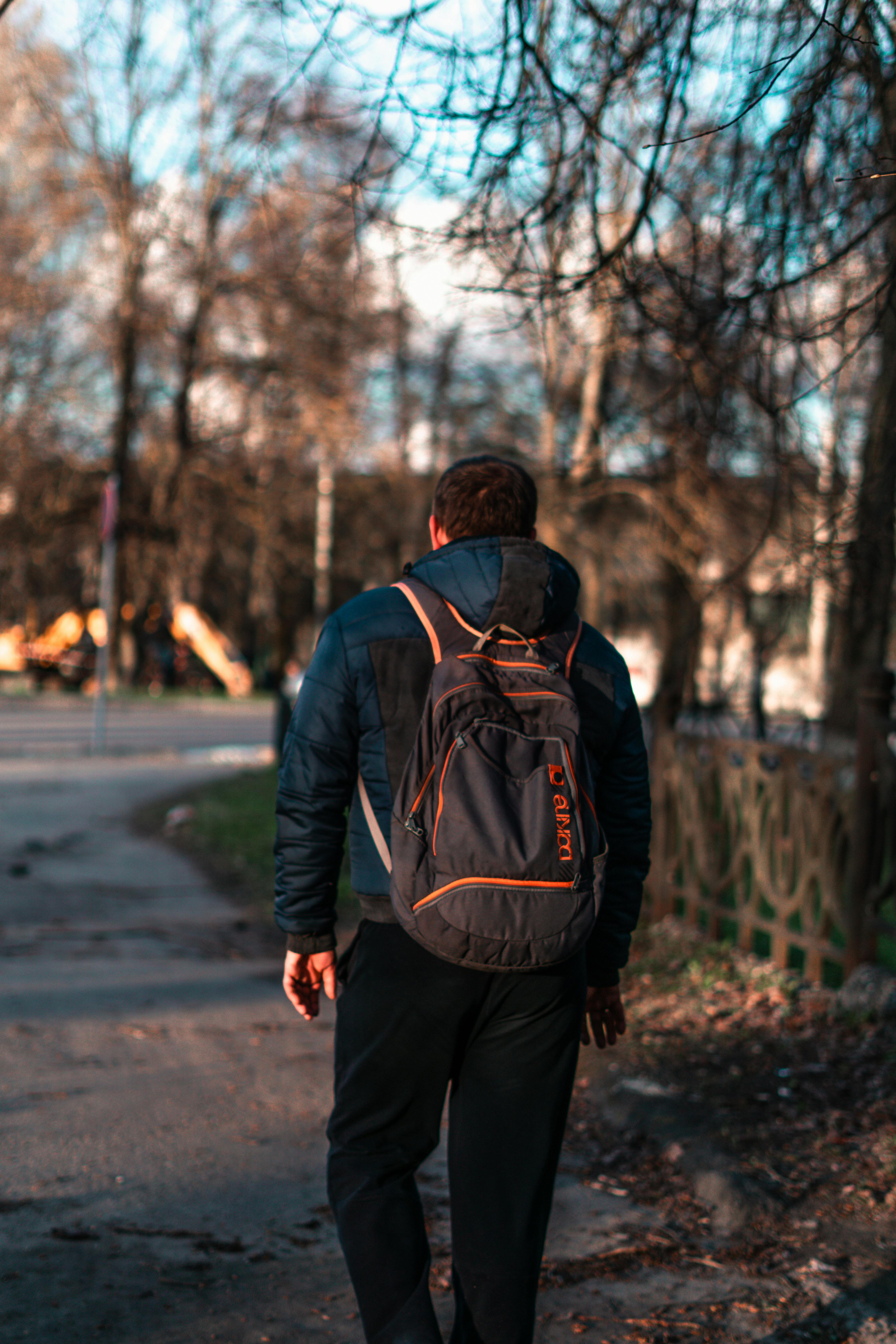 Man Carrying a Backpack while Walking · Free Stock Photo