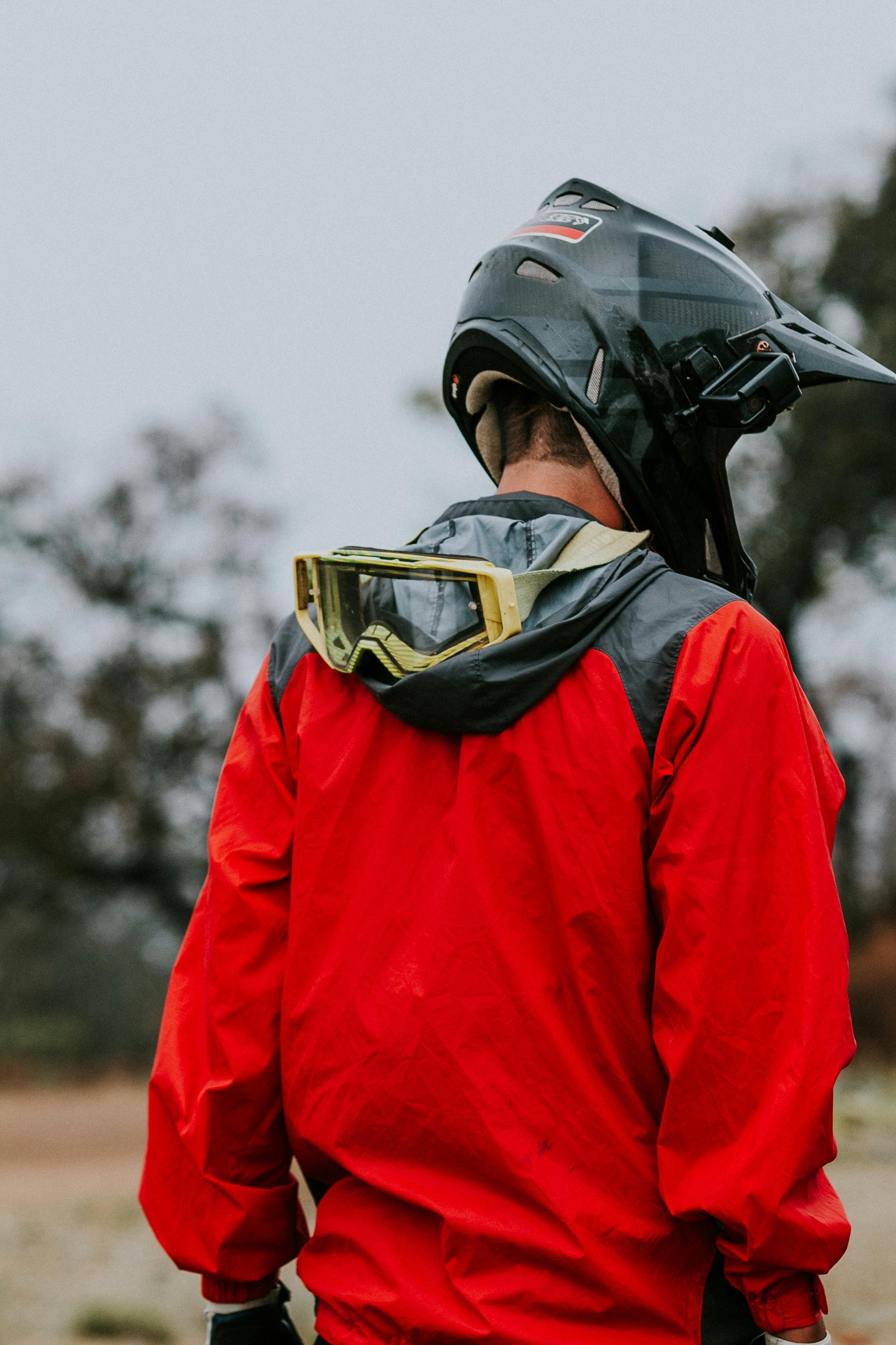 Back View of a Person in a Red Jacket and a Black Helmet · Free Stock Photo