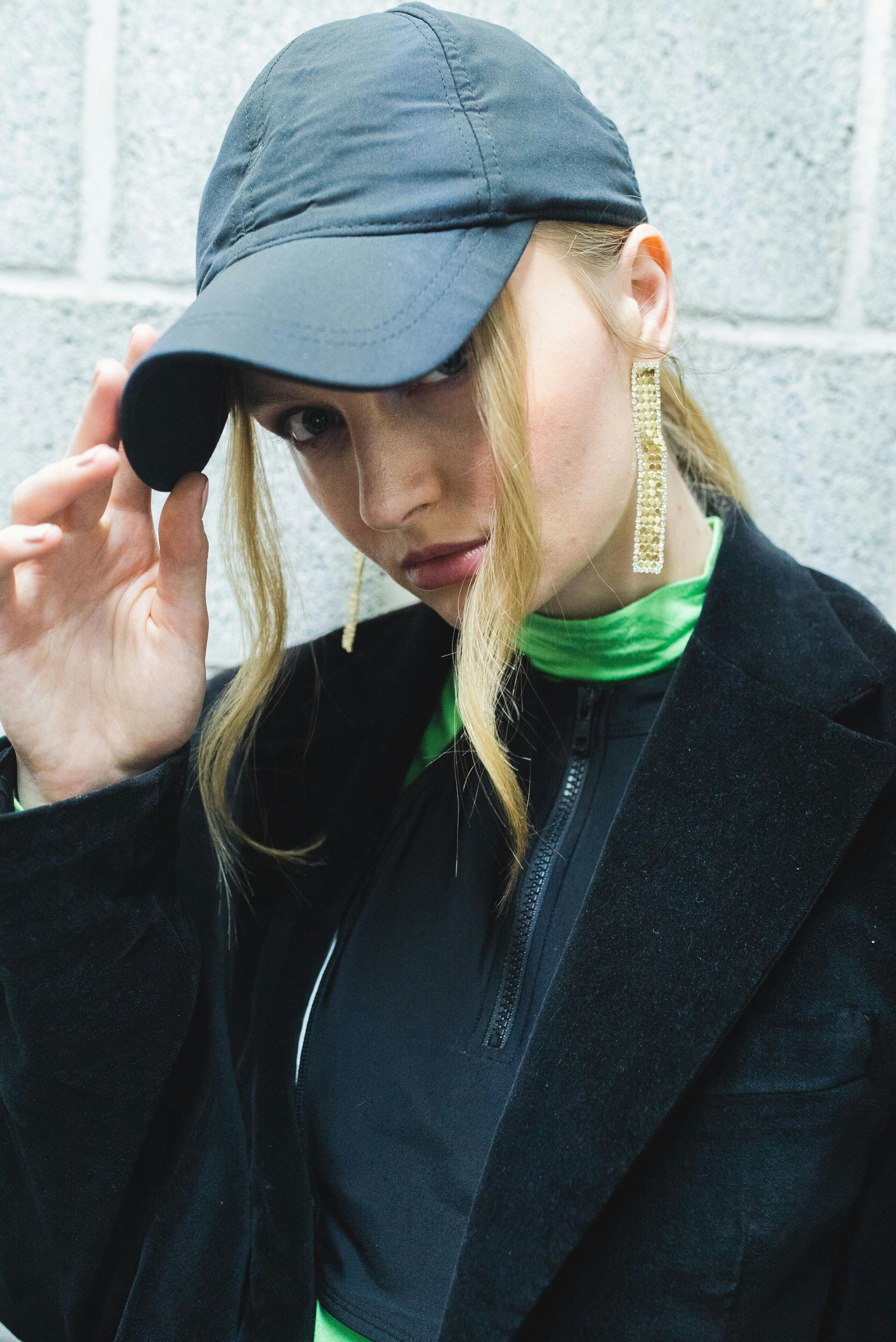 Pretty Woman Holding Her Cap · Free Stock Photo