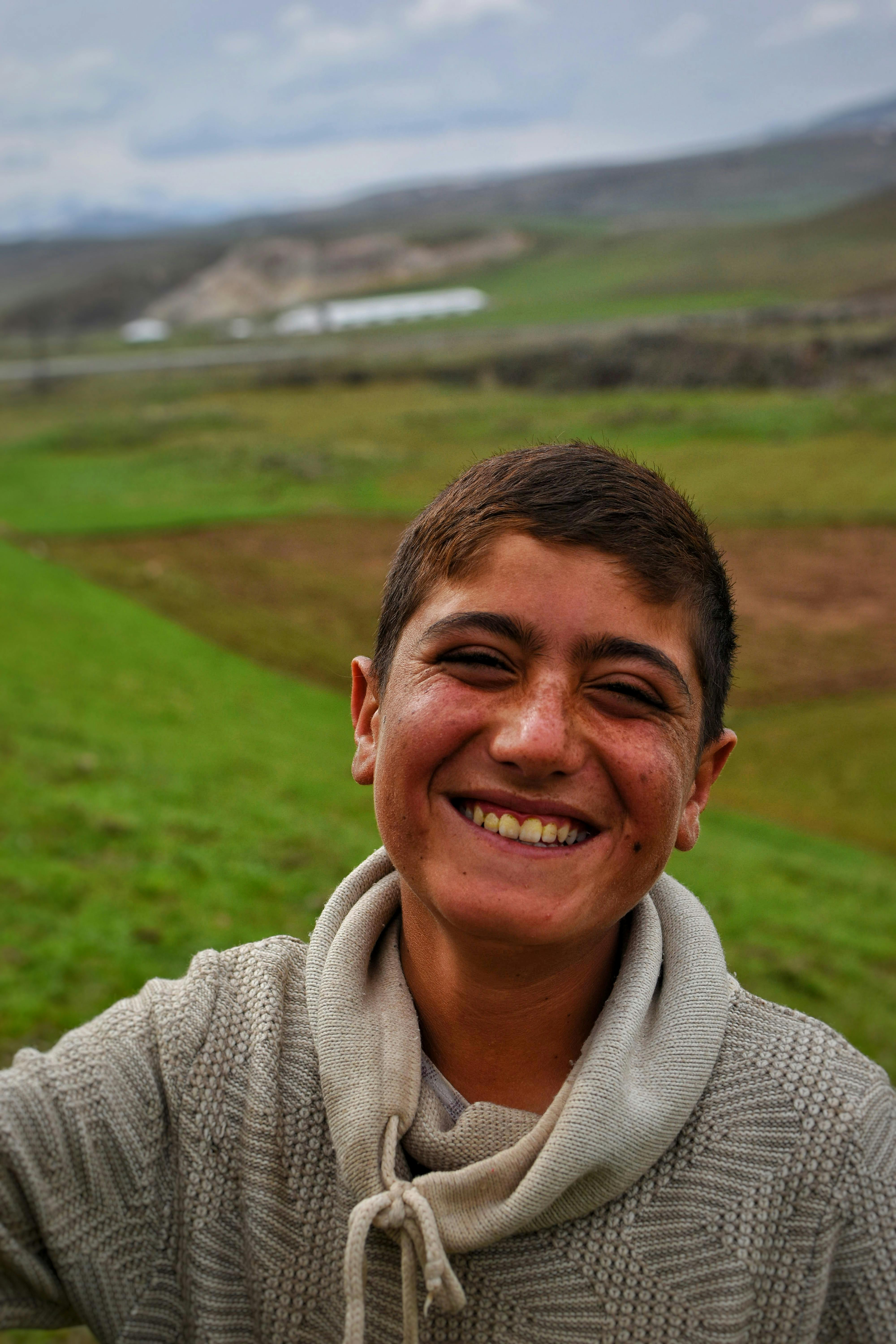 Portrait of a Young Man Smiling Outside · Free Stock Photo
